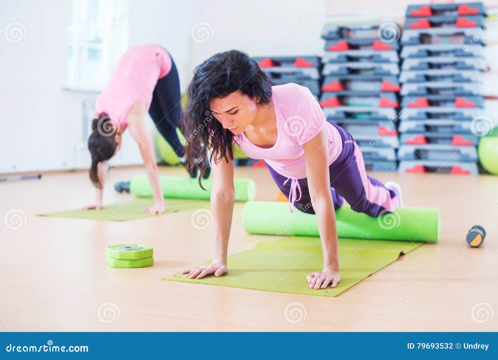 Fit Woman Stretching on Floor Using Foam Roller Doing Plank Exercise ...