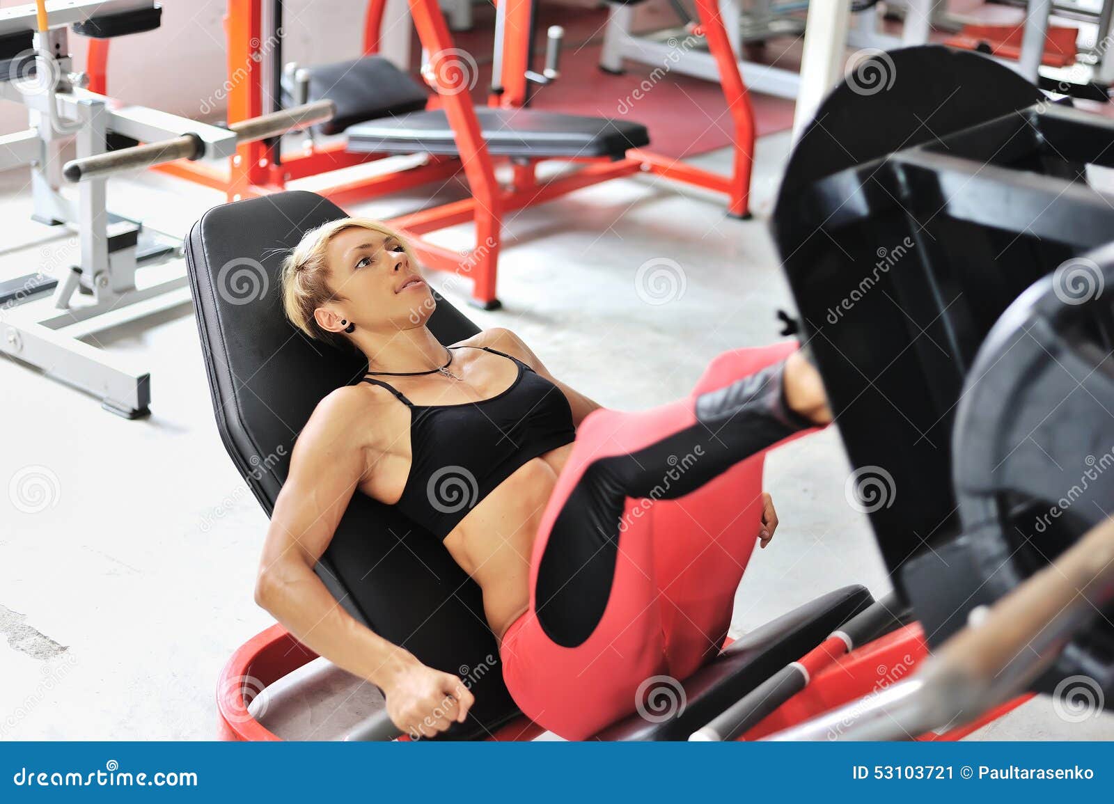 Fit Woman Training Legs on a Leg Simulator at the Gym Stock Image ...