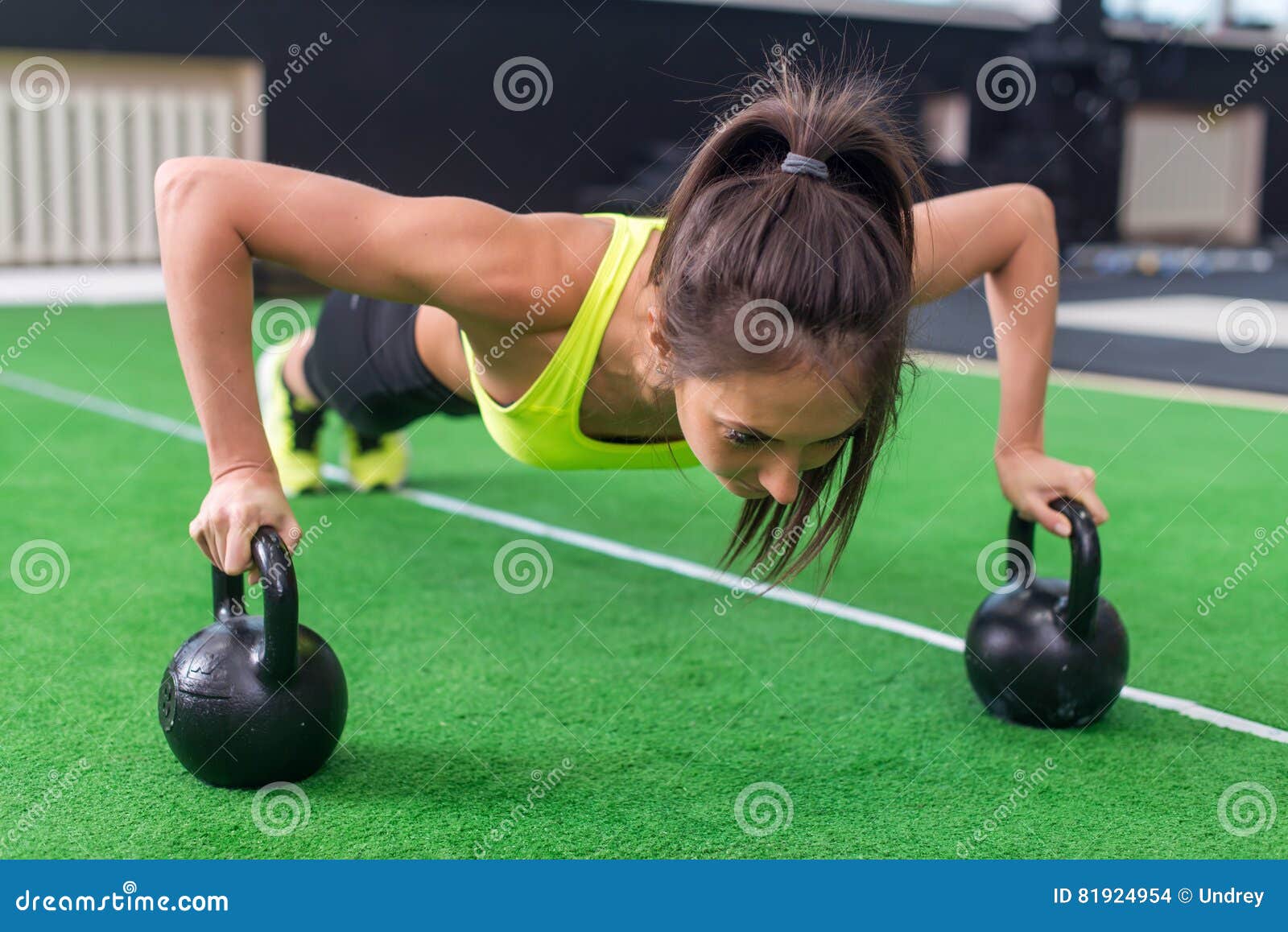 Fit Woman Young Doing Push Ups Exercise with Dumbbells in the Gym Stock ...