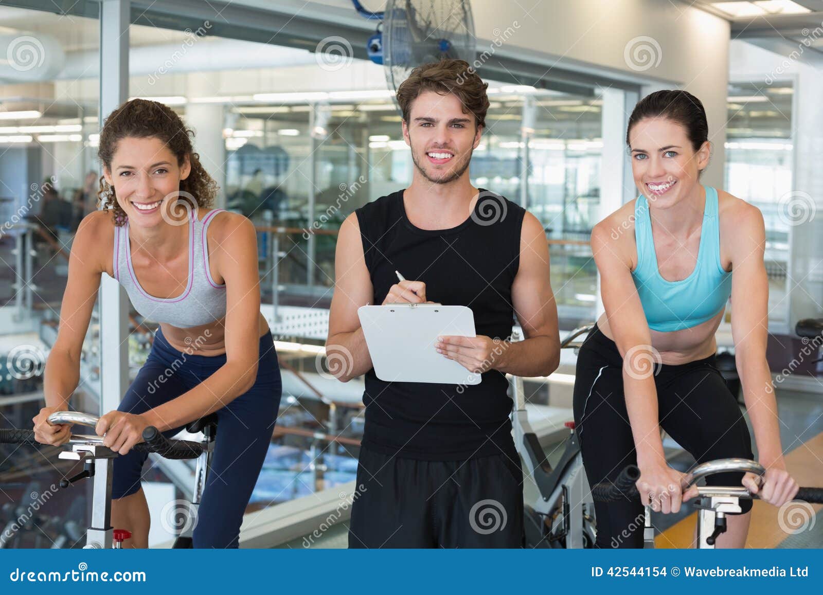 Fit Women in a Spin Class with Trainer Smiling at Camera Stock Photo ...