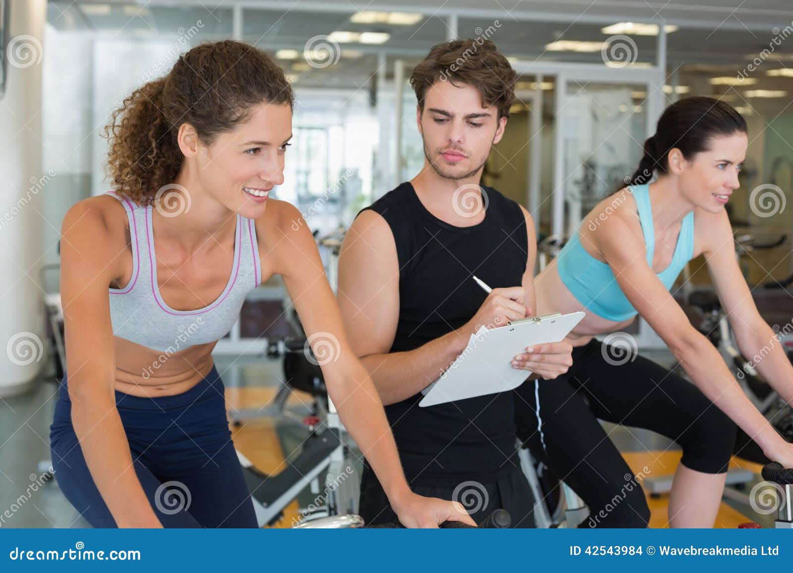Fit Women in a Spin Class with Trainer Taking Notes Stock Photo - Image ...