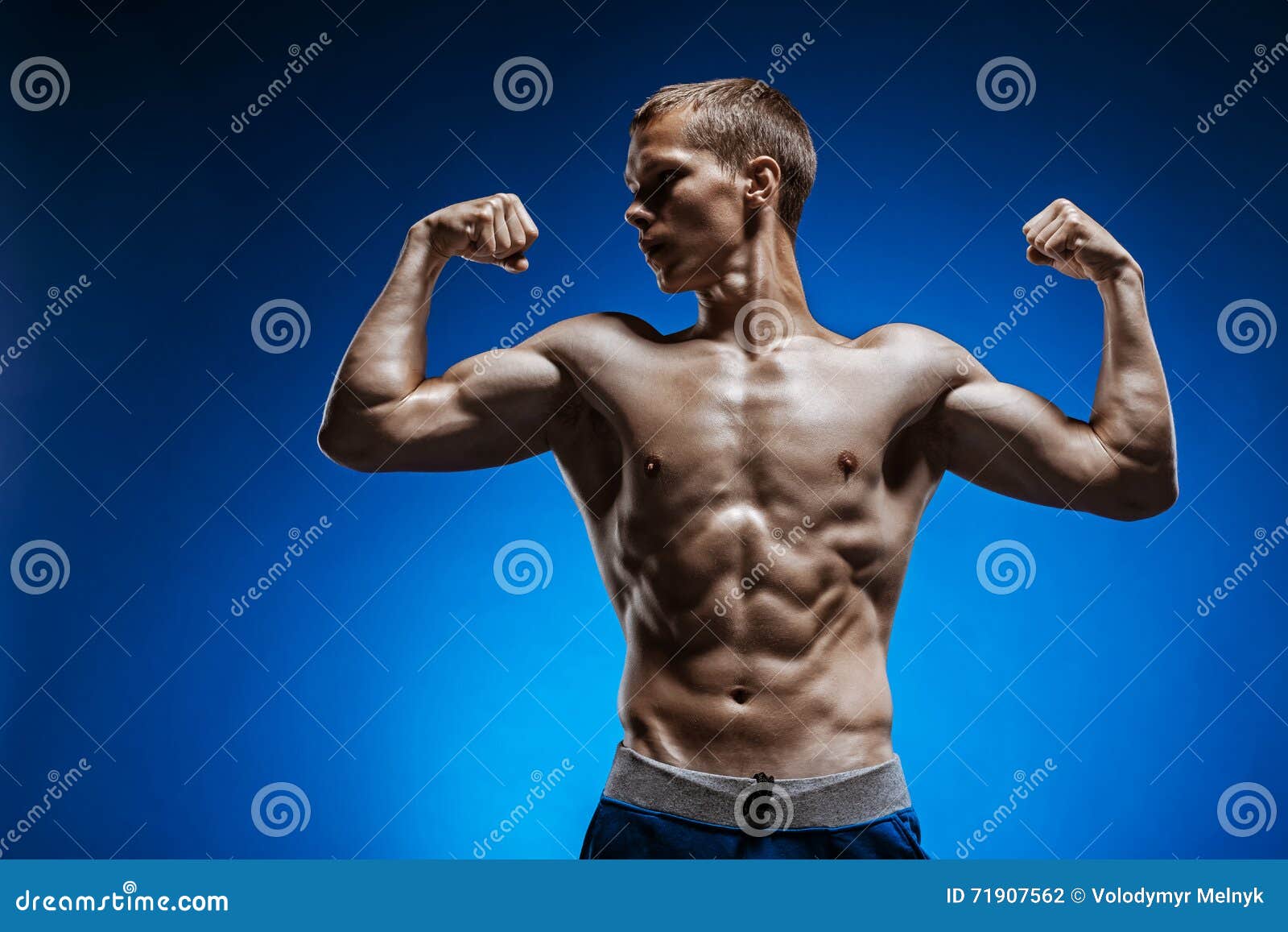 Fit Young Man with Beautiful Torso on Blue Background Stock Photo ...
