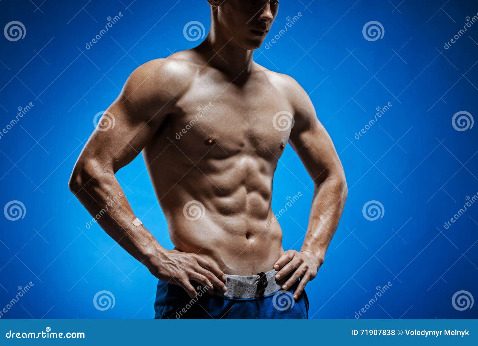 Fit Young Man with Beautiful Torso on Blue Background Stock Photo ...