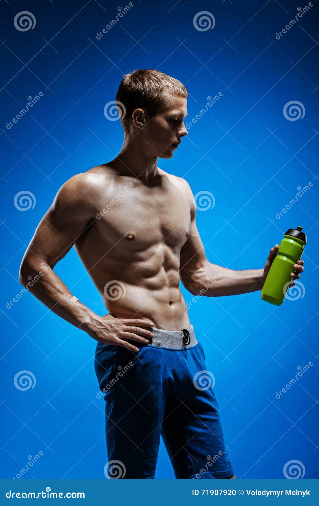 Fit Young Man with Beautiful Torso on Blue Background Stock Photo ...