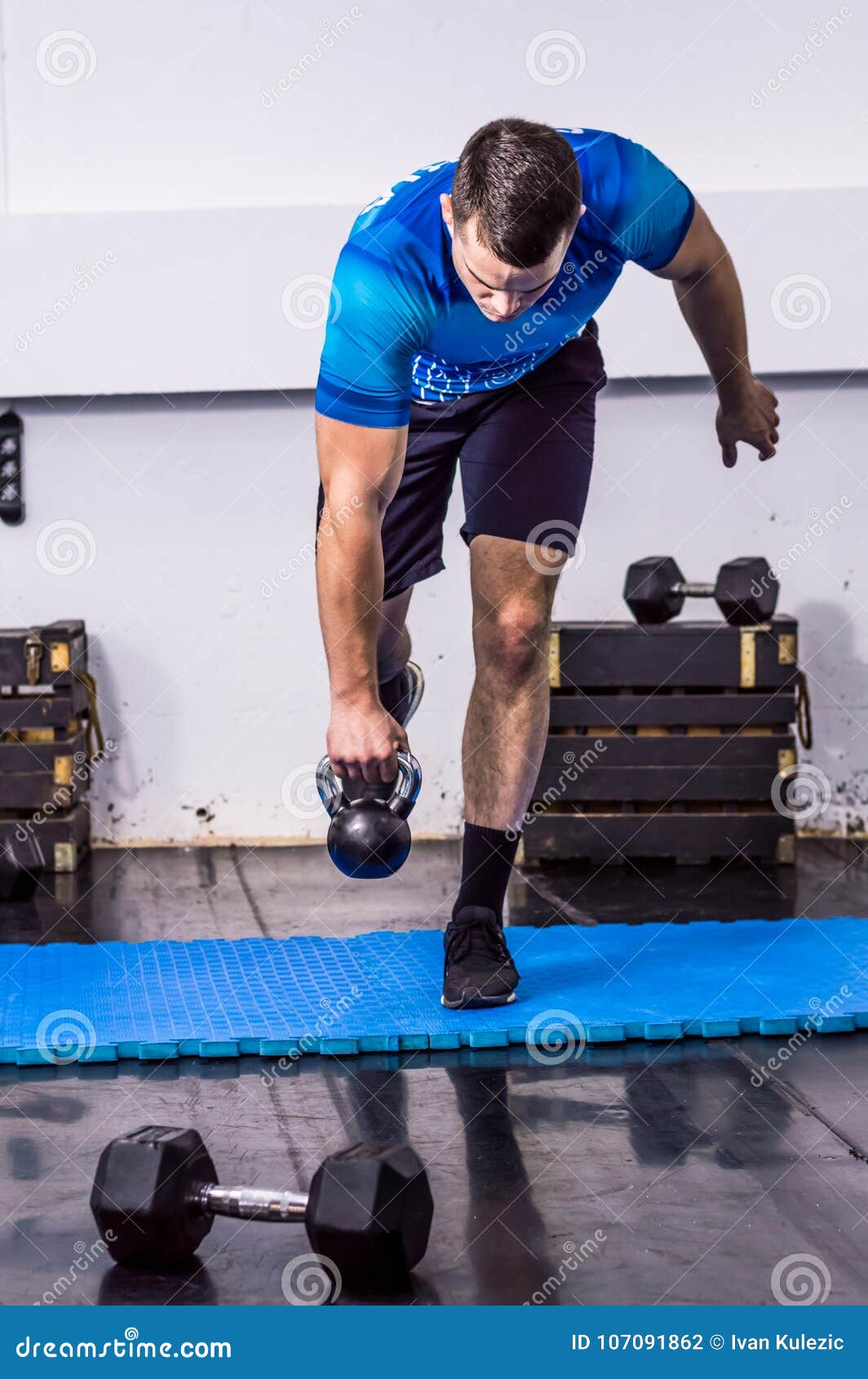 Fit Young Man Doing Kettle Bell Exercise at the Gym Stock Photo - Image ...