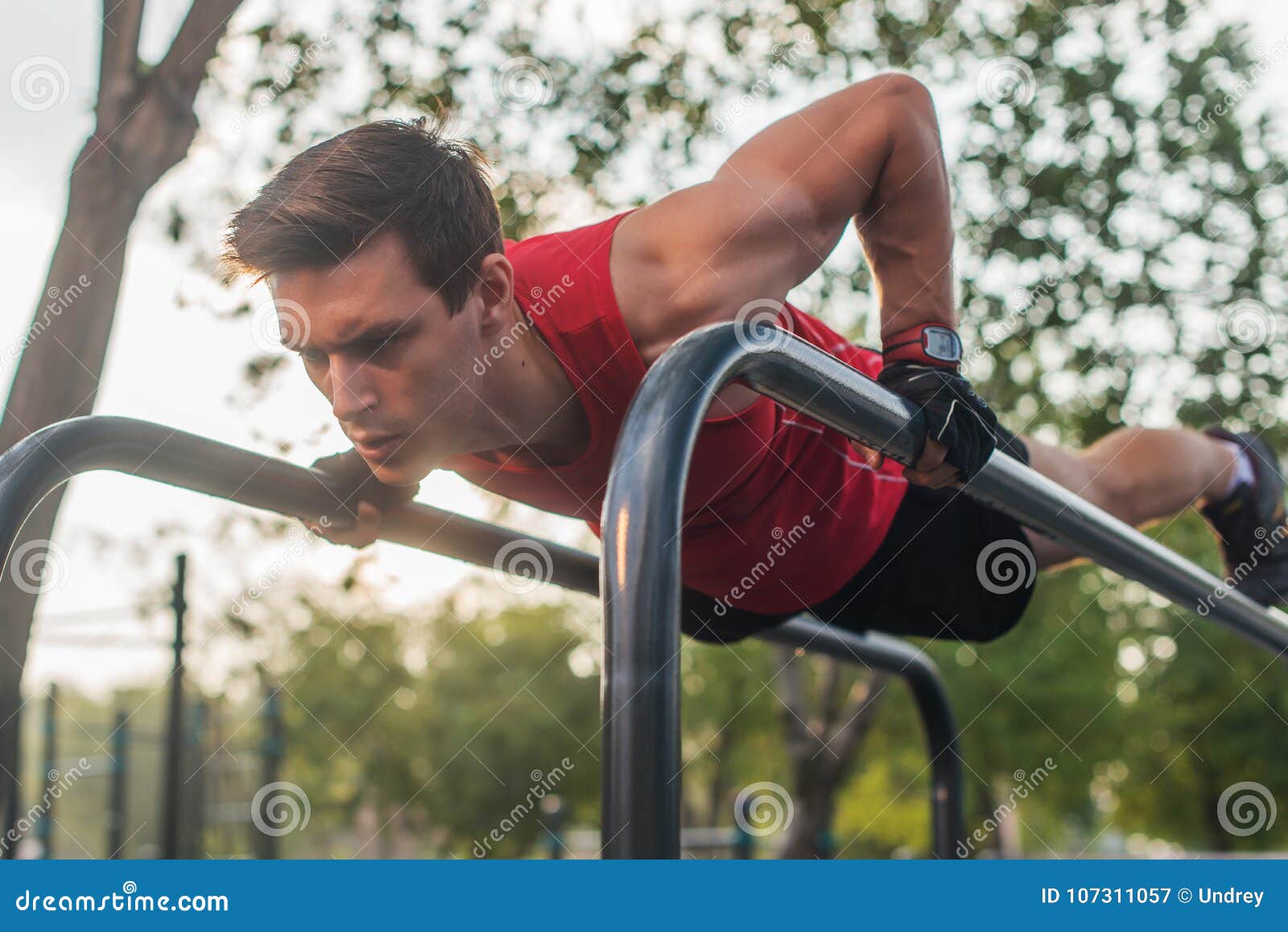 Fit Young Man Doing Push Ups on Horizontal Bar Outdoors Stock Image ...