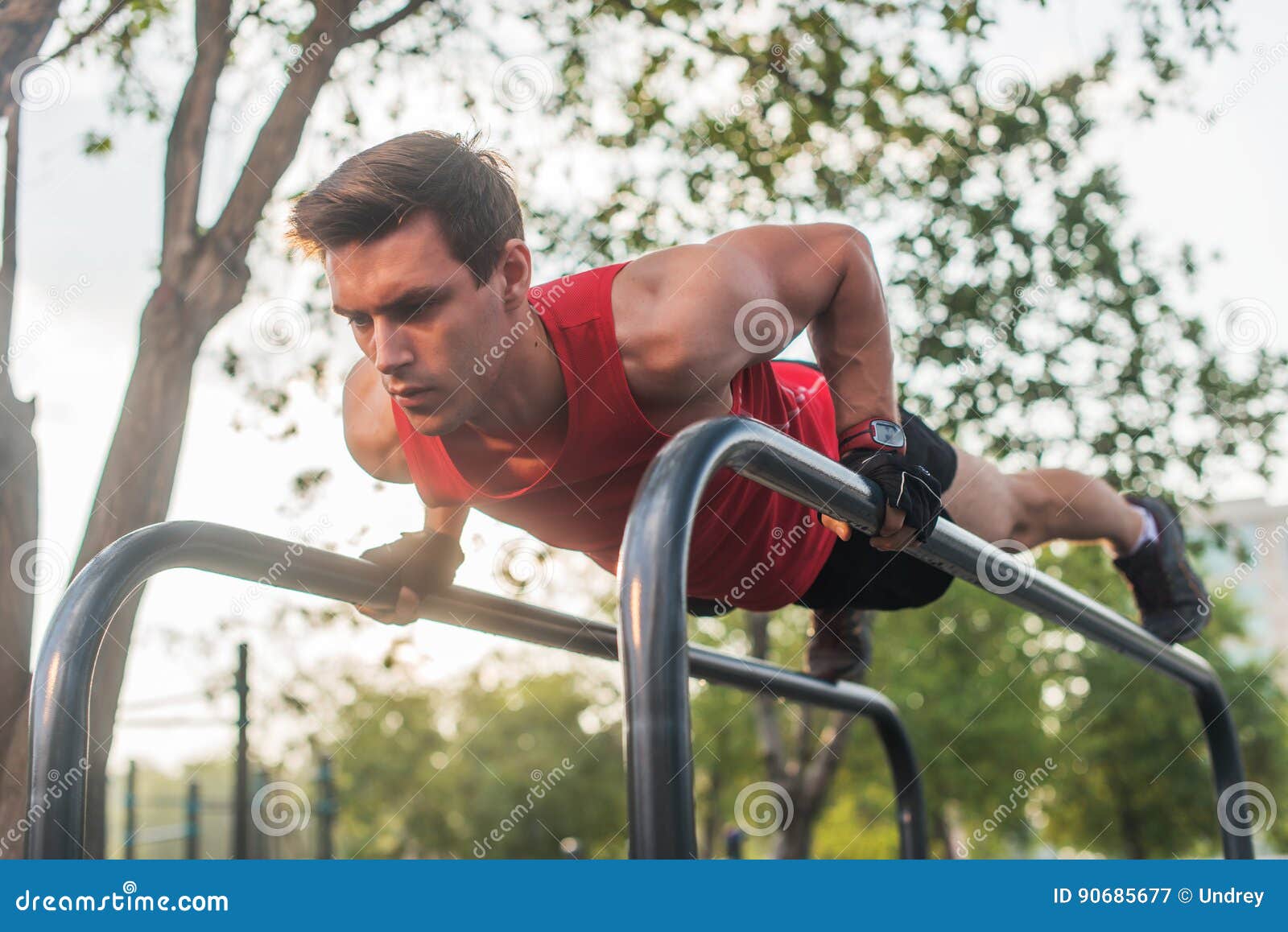 Fit Young Man Doing Push Ups on Horizontal Bar Outdoors Stock Image ...