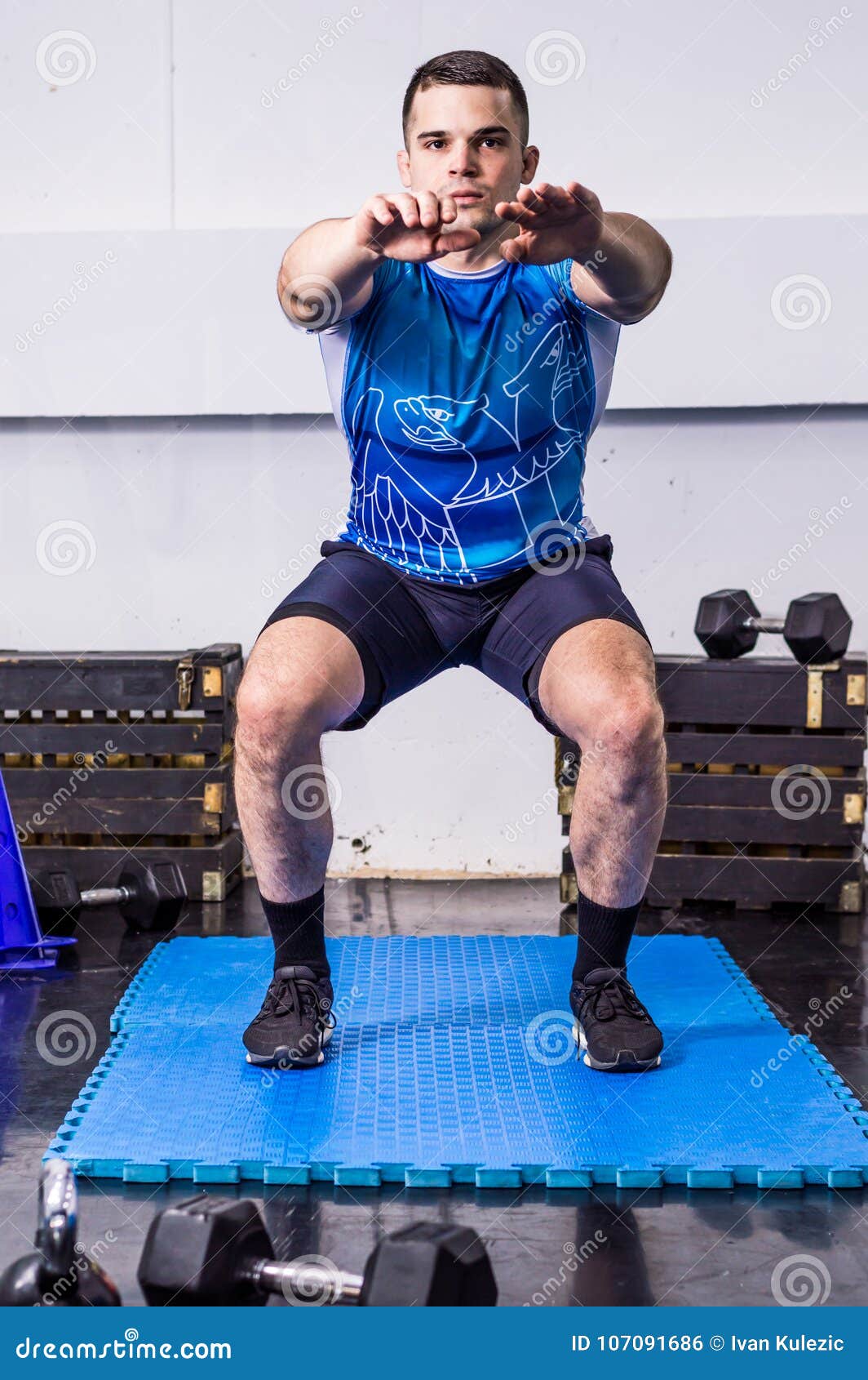 Fit Young Man Doing Squats at the Gym Stock Photo - Image of interior ...