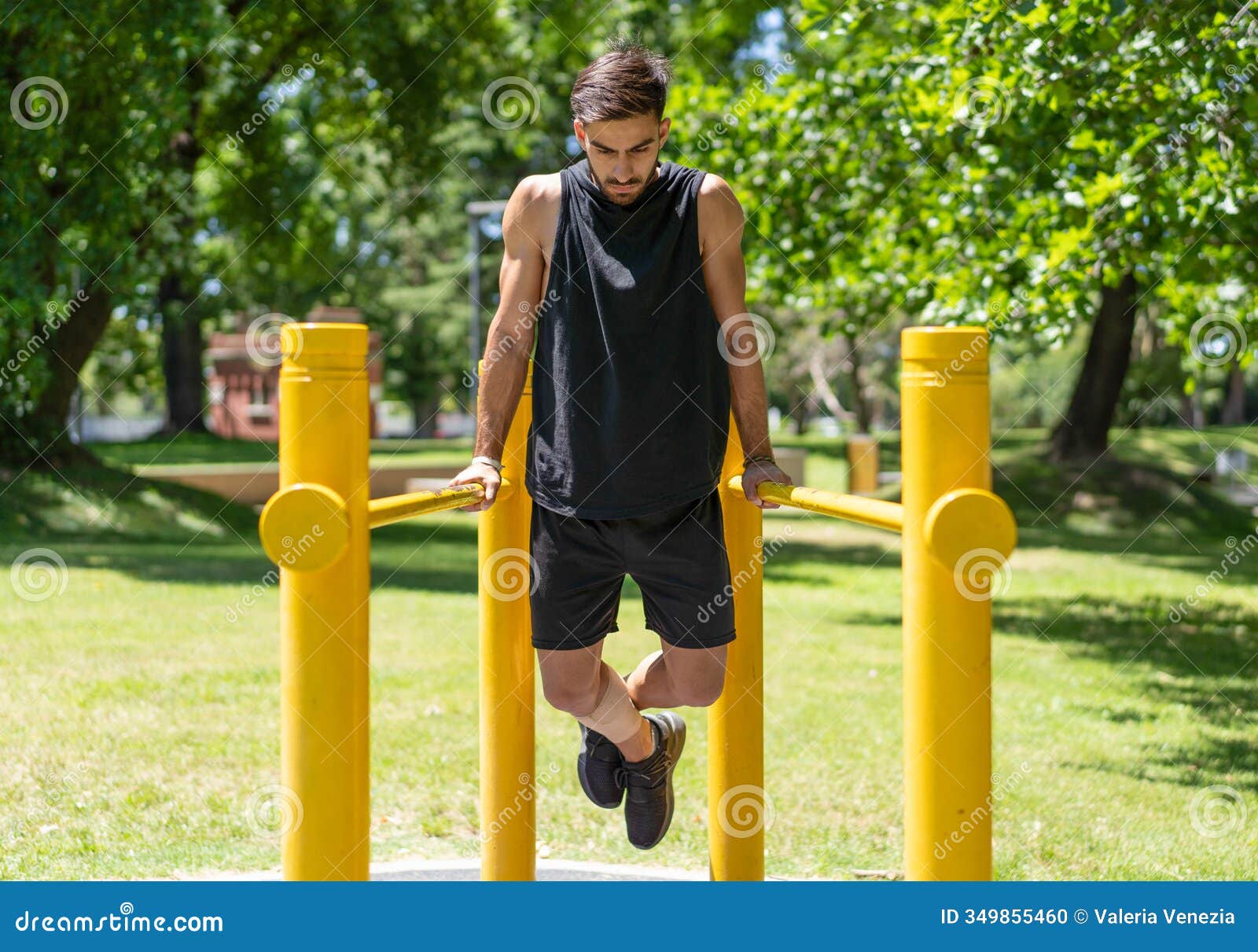 Fit Young Man Executing Dips on Outdoor Parallel Bars in the Park Stock ...