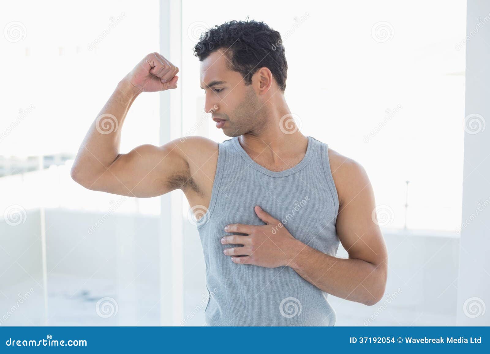 Fit Young Man Flexing Muscles in Studio Stock Photo - Image of young ...