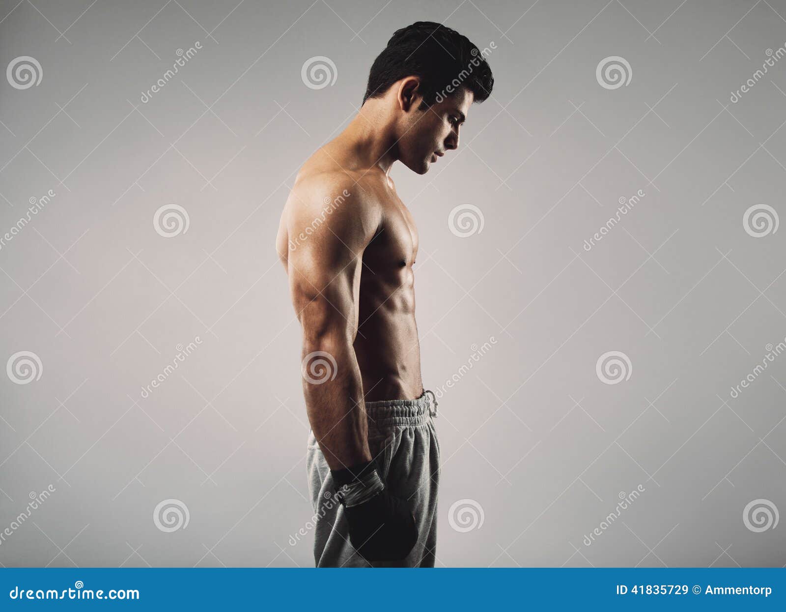 Fit Young Man Wearing Boxing Gloves Looking Down Stock Image - Image of ...