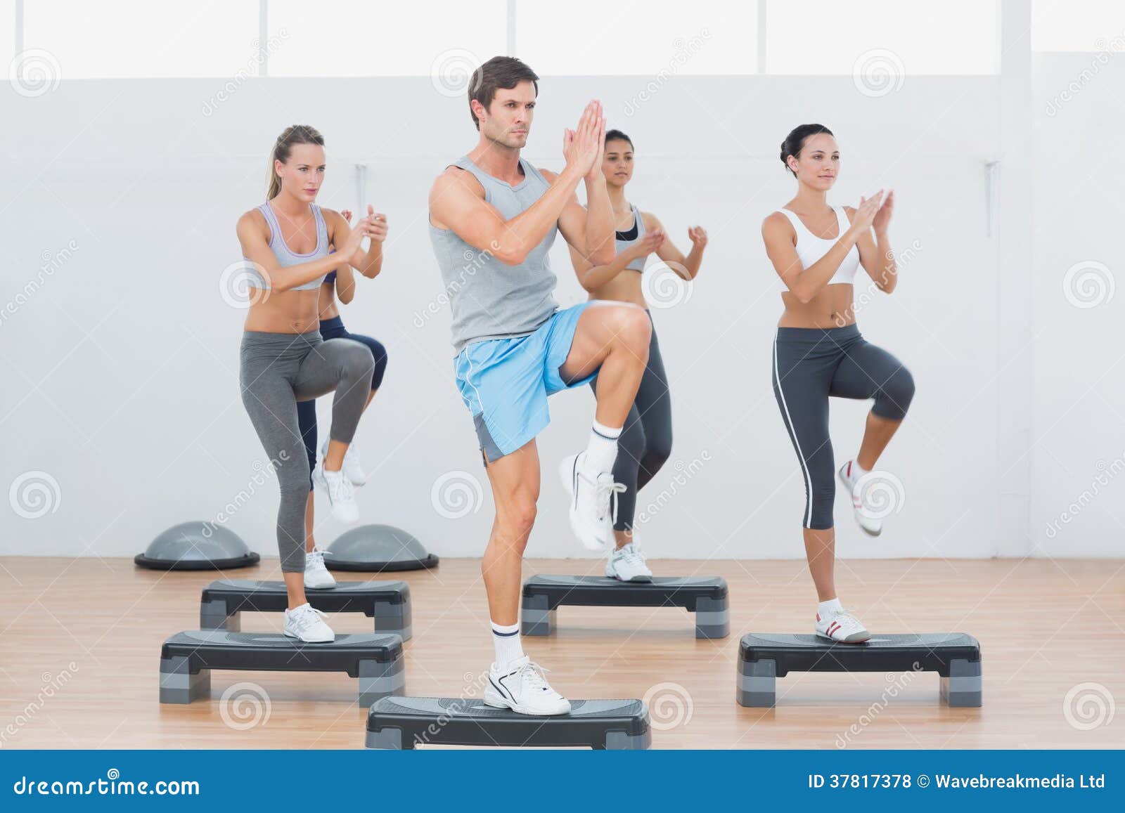 Fitness Class Performing Step Aerobics Exercise Stock Photo - Image of ...