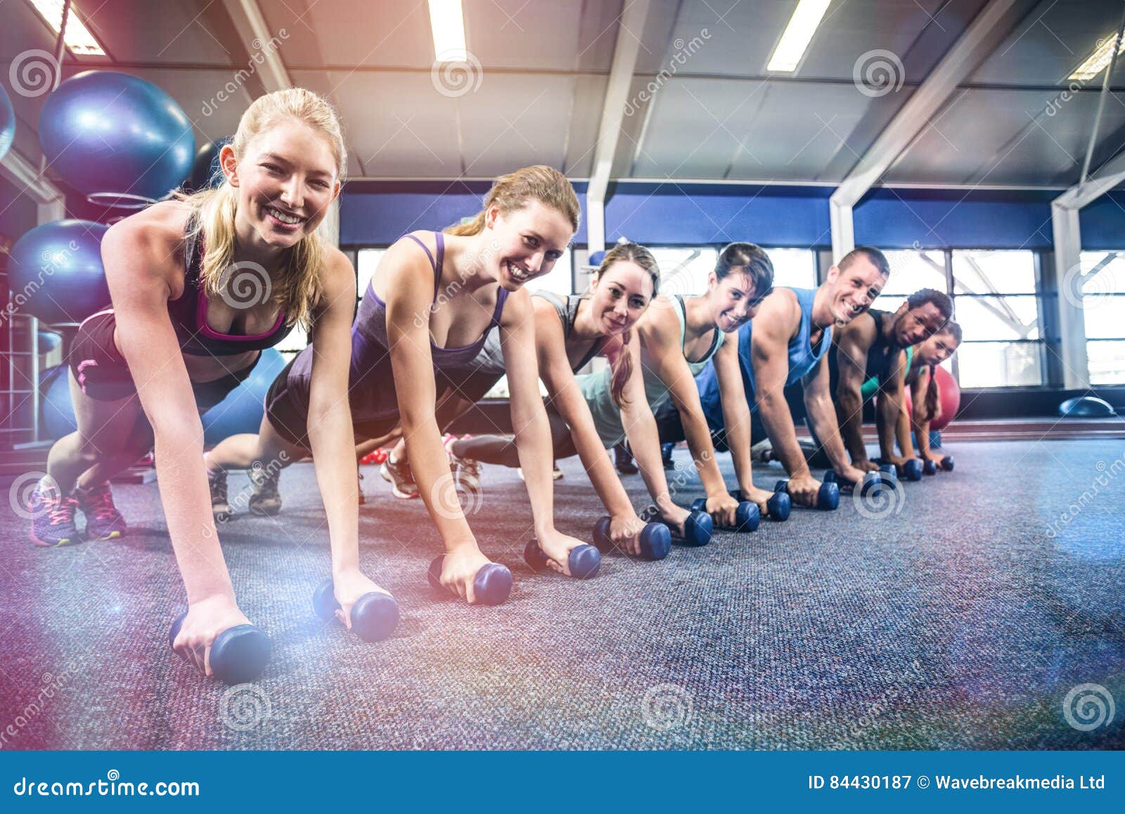 Fitness Class in Plank Position with Dumbbells Stock Image - Image of ...