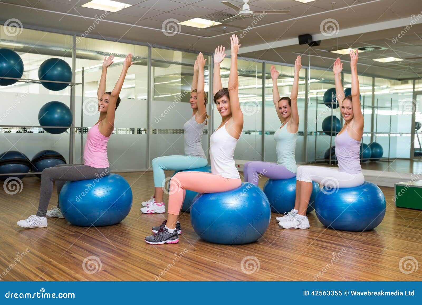 Fitness Class Sitting on Exercise Balls in Studio Stock Image - Image ...