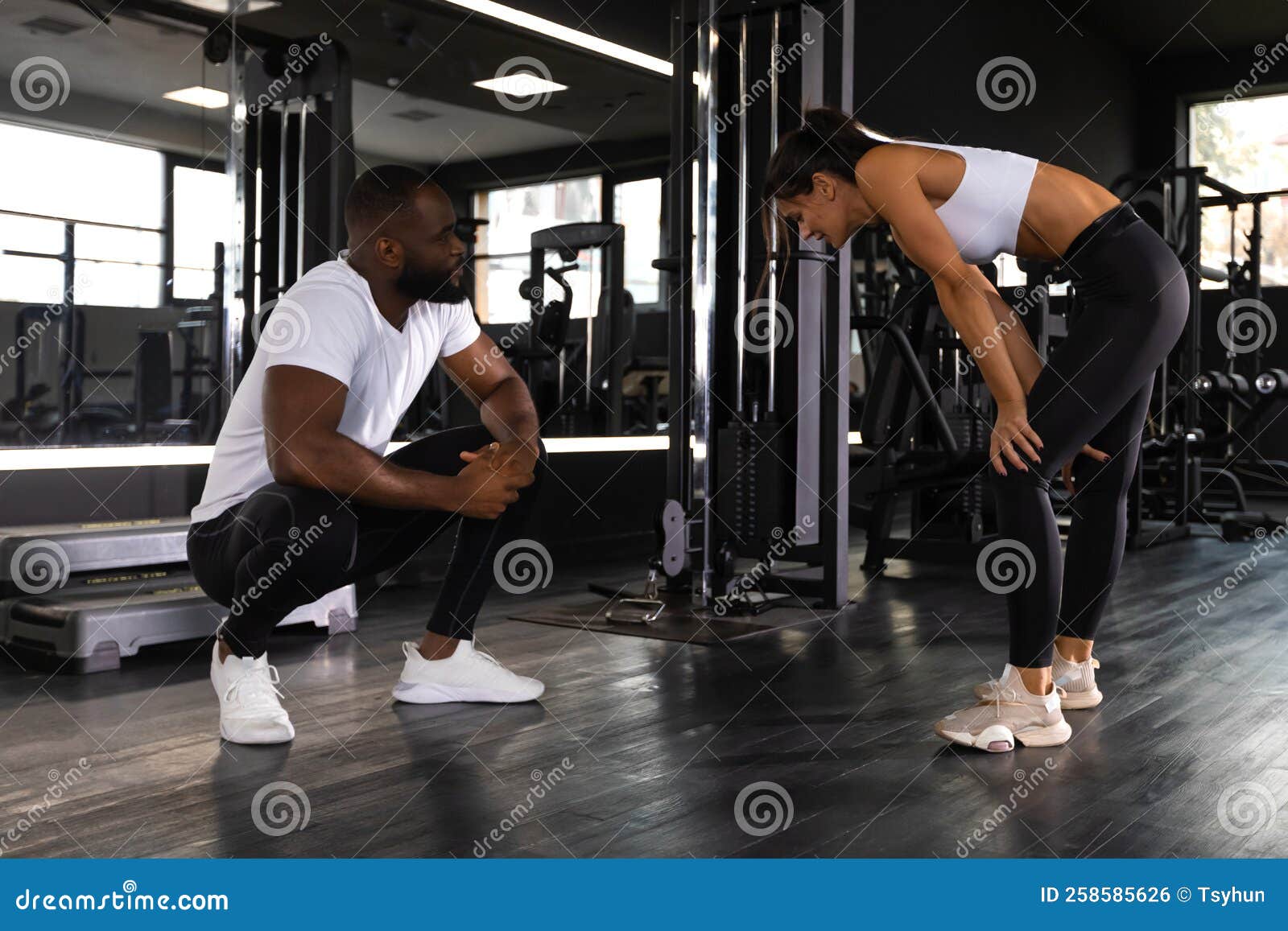 Fitness Instructor Exercising with His Client at the Gym. Stock Photo ...