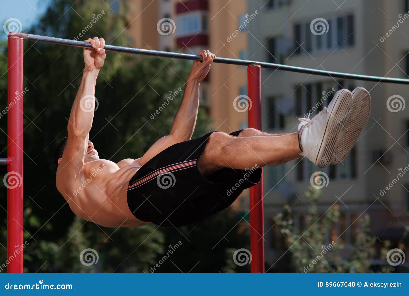 Fitness Man Doing Stomach Workouts on Horizontal Bar Outdoors Stock ...