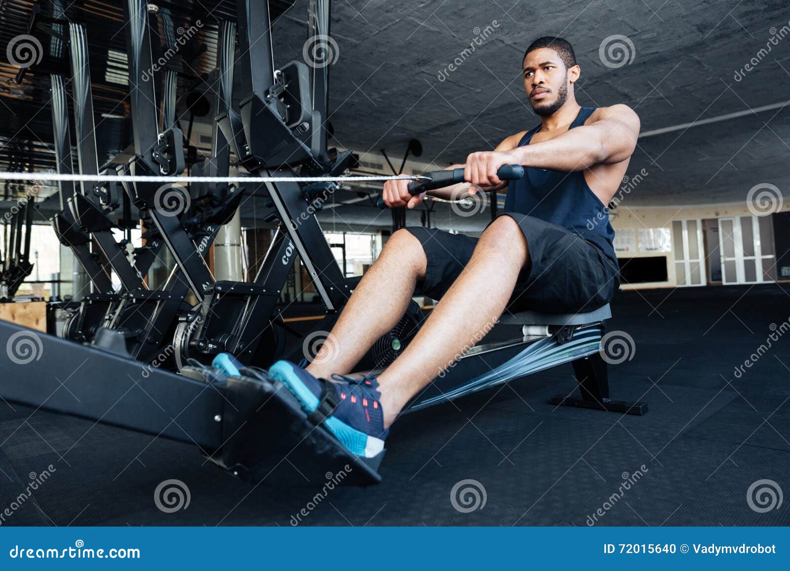 Fitness Man Using Rowing Machine at Gym Stock Photo - Image of ...
