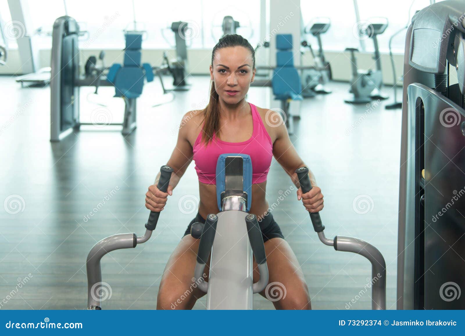 Fitness Woman Doing Exercise for Back on Machine Stock Photo - Image of ...