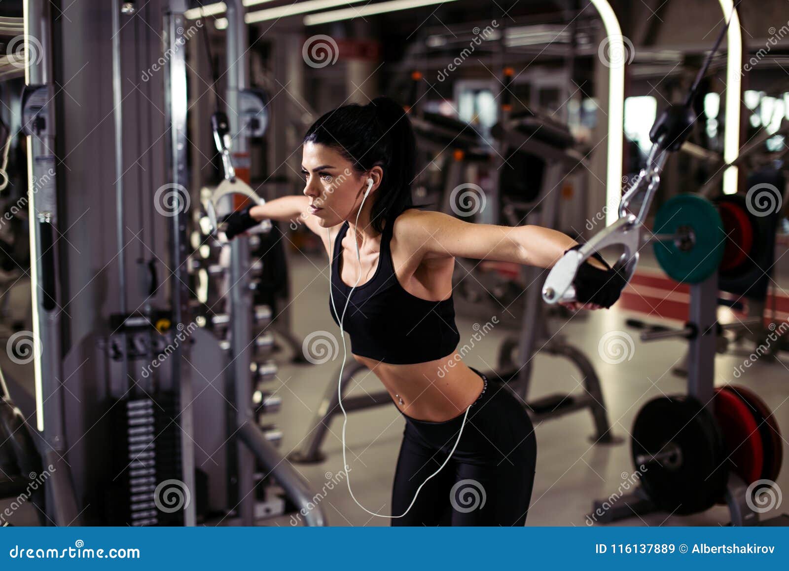 Fit Woman Execute Exercise with Exercise-machine Cable Crossover in Gym ...