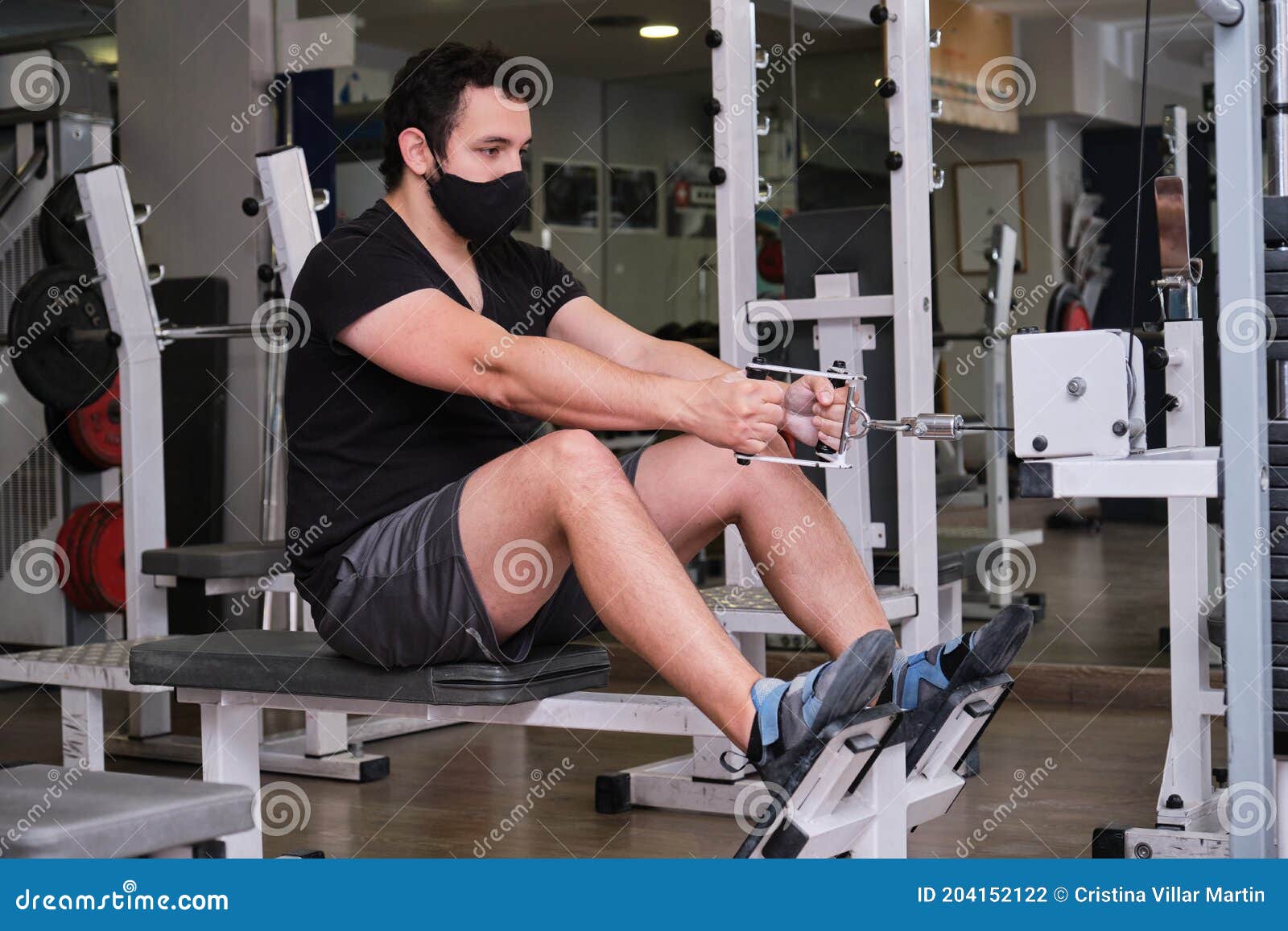 Fitness Young Man Wearing Protective Face Mask Using Rowing Machine in ...