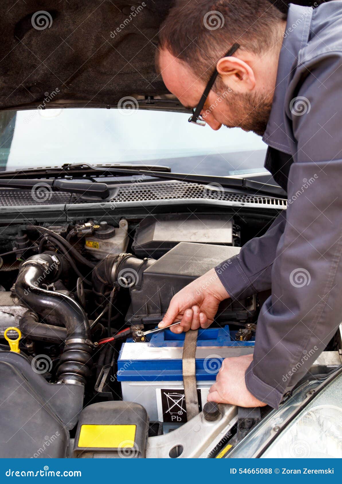 Fitting a battery to a car stock photo. Image of mini - 54665088