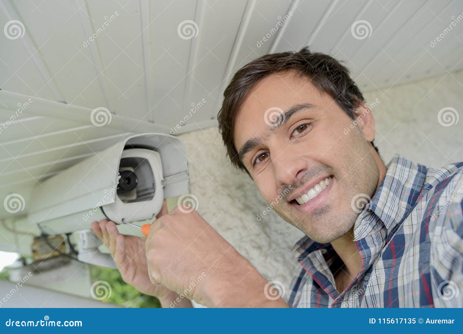 Fitting a security camera stock image. Image of guard - 115617135