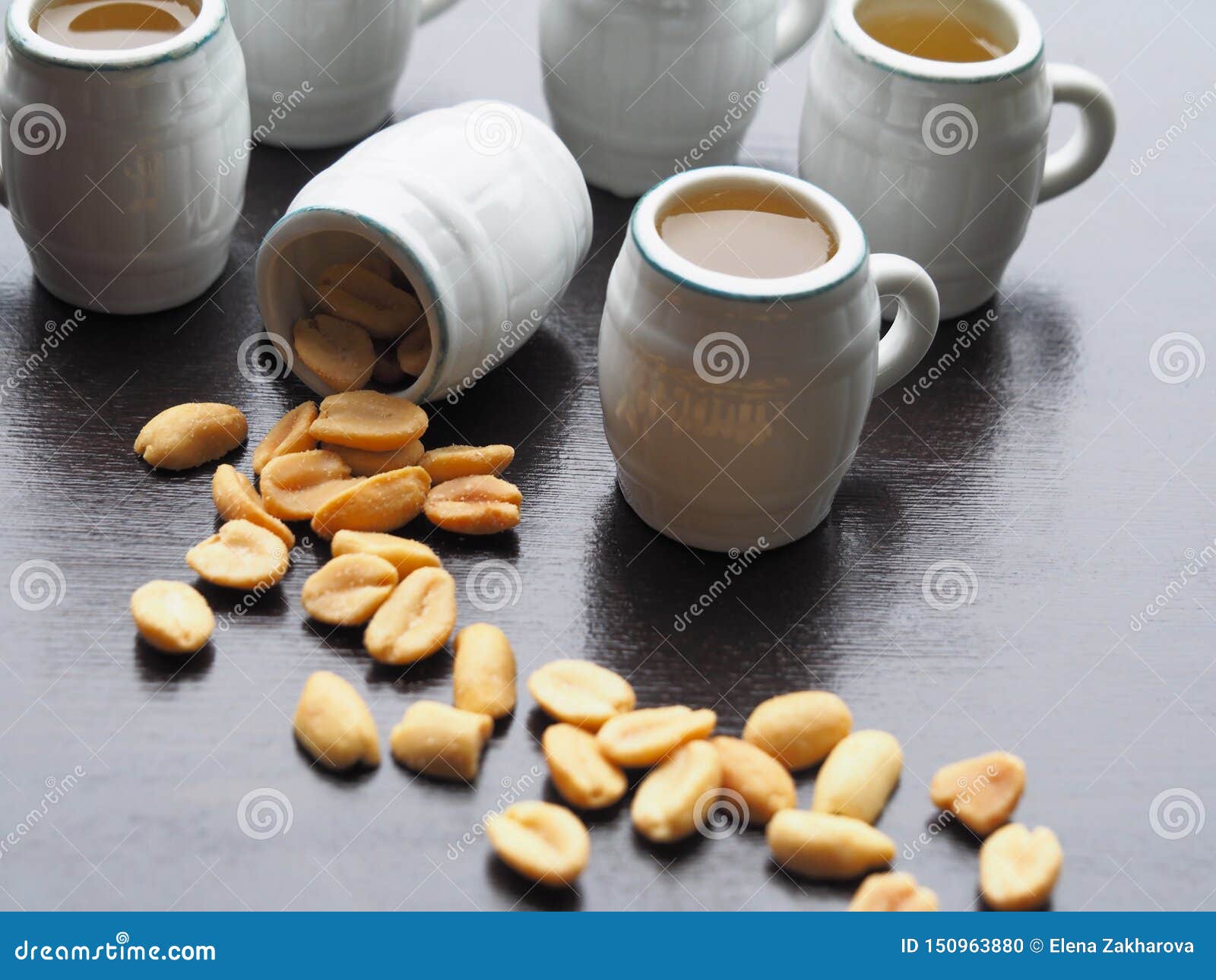 Five Beer Mugs and One Mug with Nuts on a Wooden Table Stock Photo ...