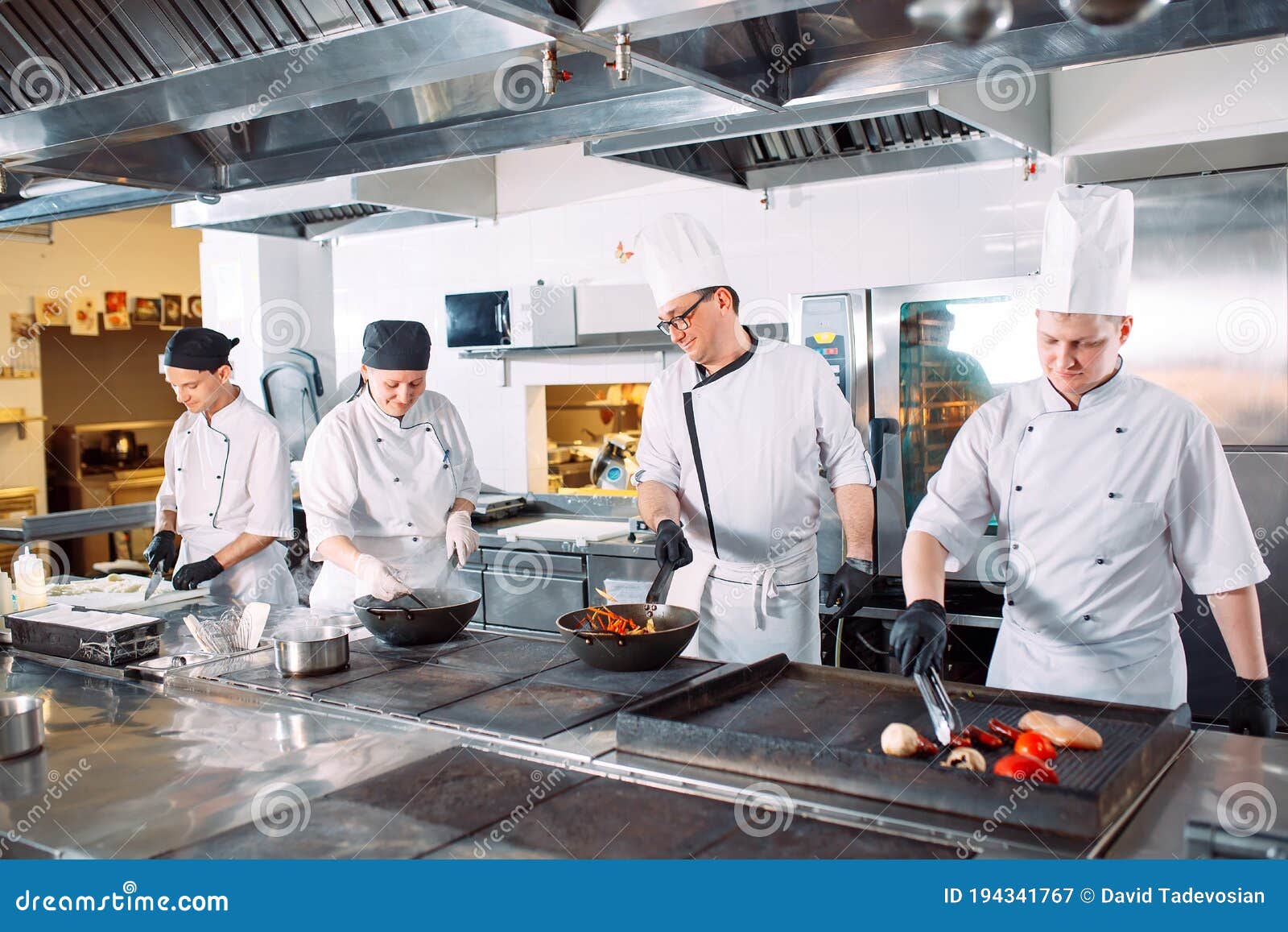 Five Chefs Wearing Uniforms Posing in a Kitchen . Stock Image - Image ...