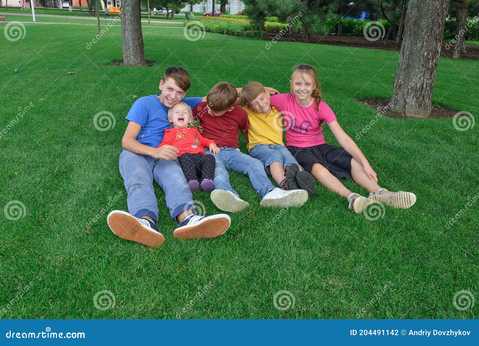 Five Children are Sitting in the Park on the Green Grass Stock Photo ...