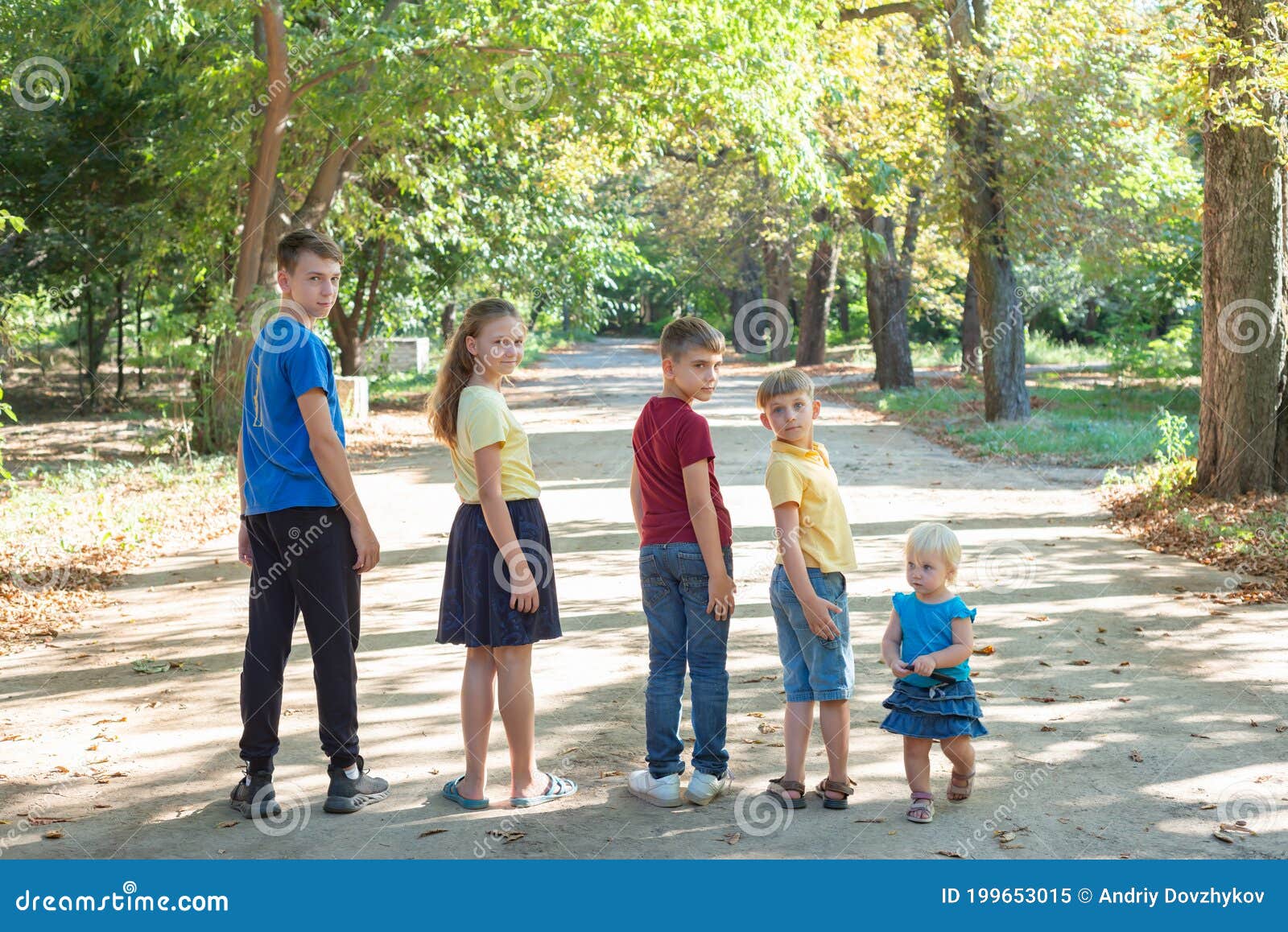Five Children Stand in a Row in Height in the Park, Walking and Stock ...