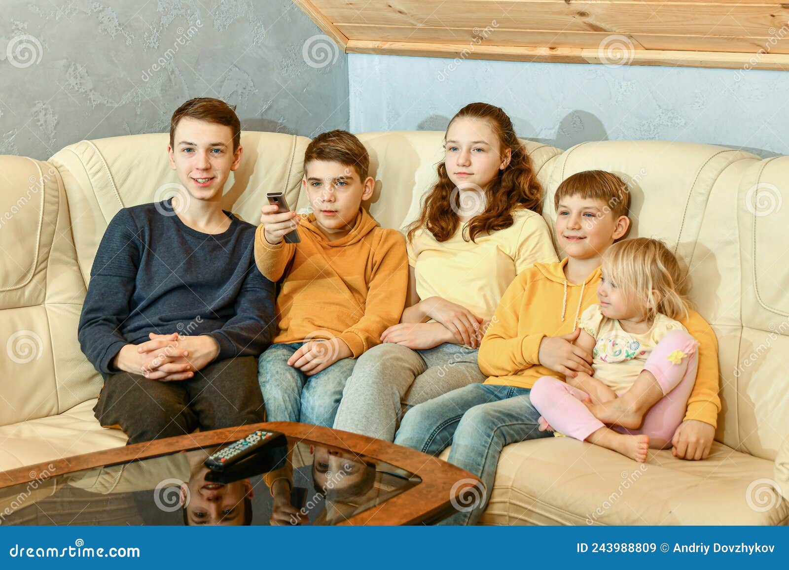 Five Children Watch TV and Switch Channels with a Remote Control Stock ...