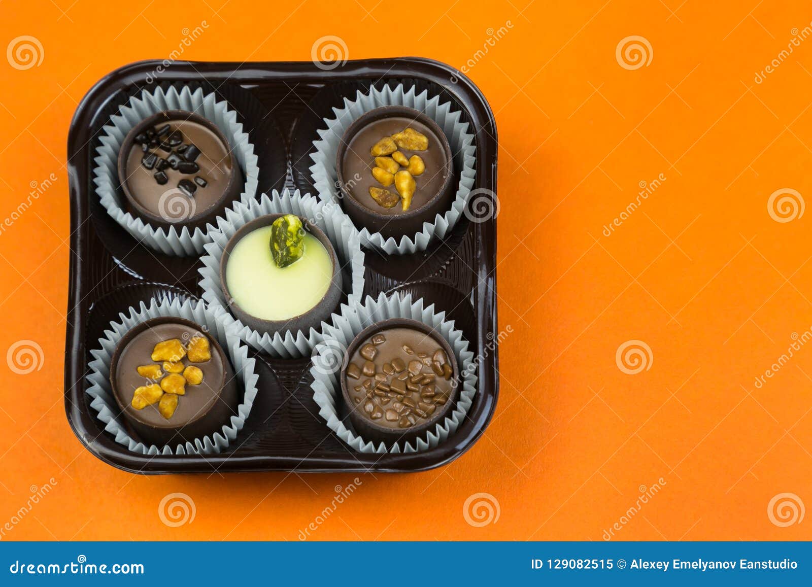 Five Chocolates on a Colored Background. Stock Image - Image of ...