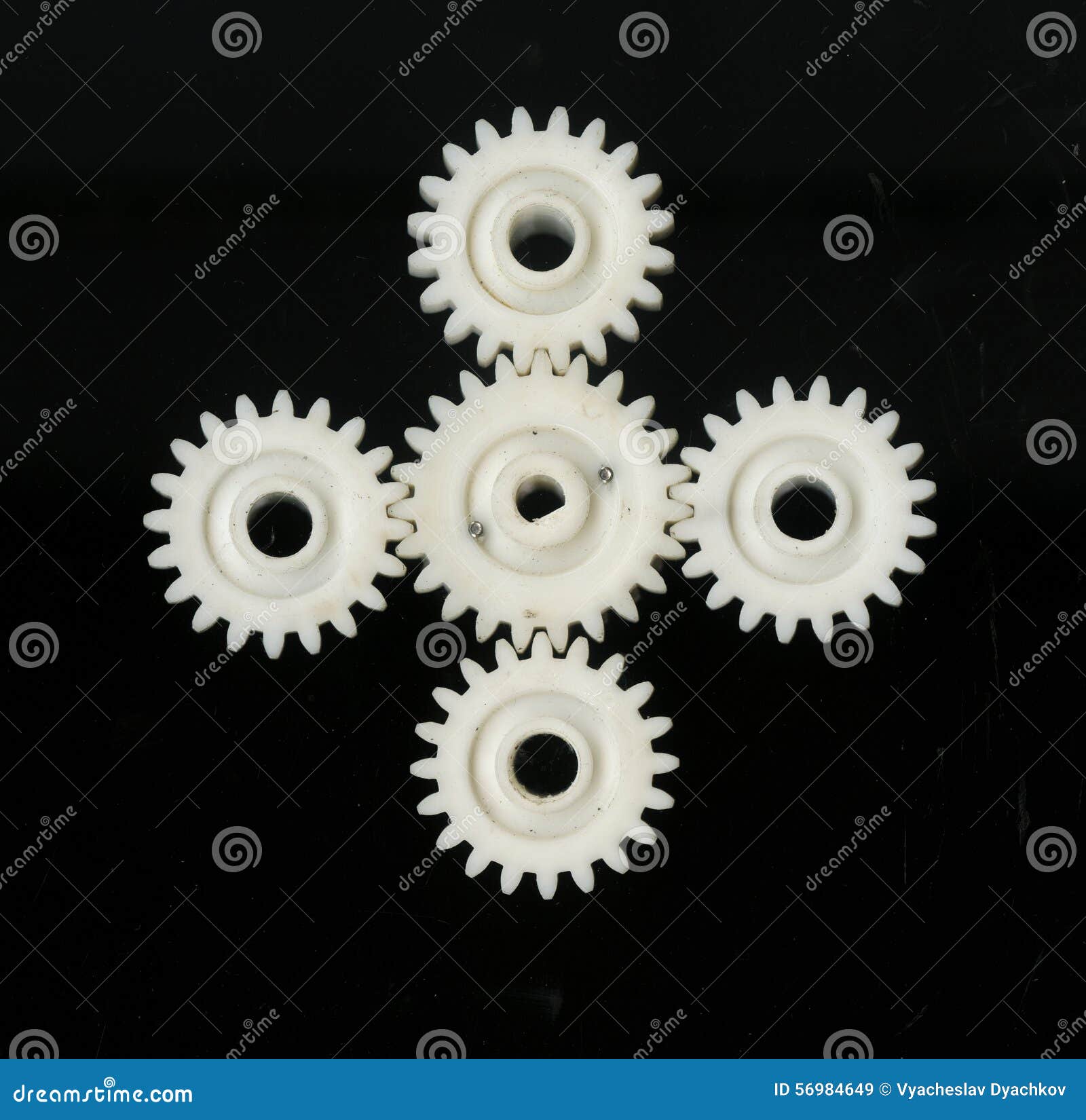 Five Concatenated White Plastic Toothed Gears of Different Sizes on a ...