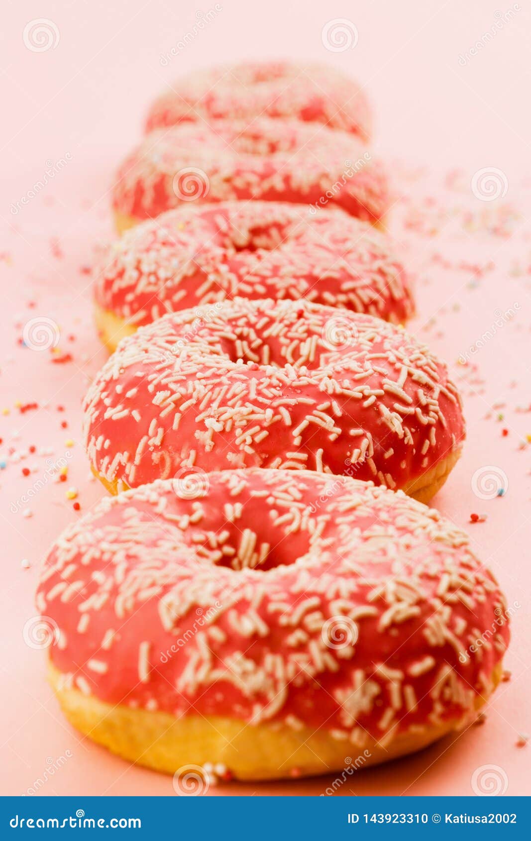 Five Coral Donuts Standing in a Line. Donuts with Icing Stock Photo ...