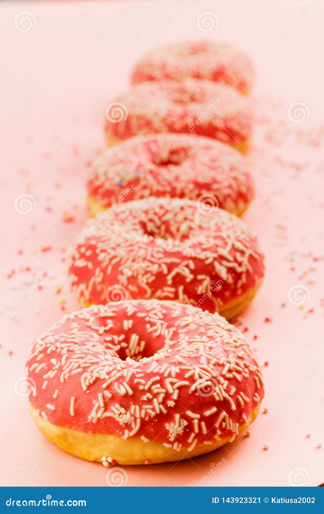 Five Coral Donuts Standing in a Line. Donuts with Icing Stock Image ...