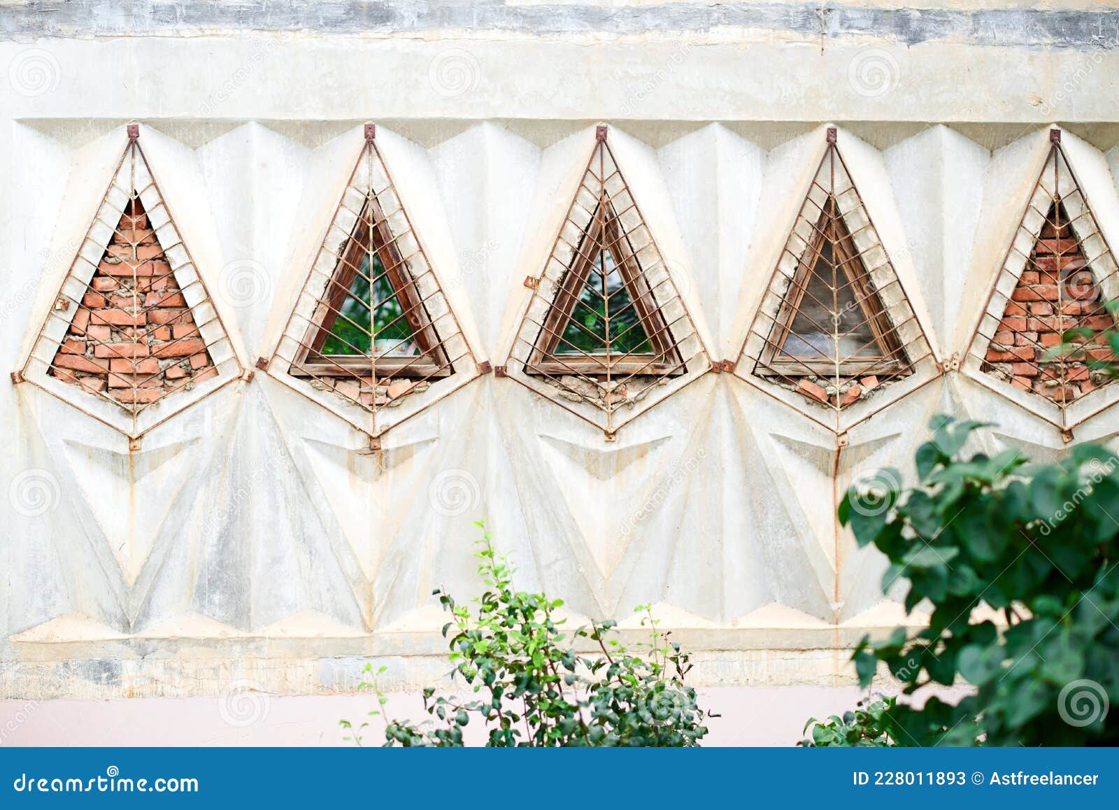Five Diamond-shaped Windows, Some of Which are Bricked, on a White Wall ...