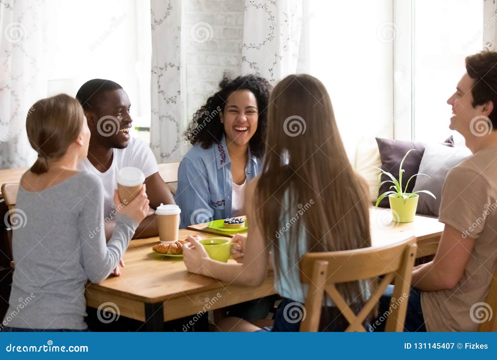 Five Multiracial Young People Having Fun Sitting in Cafe Stock Image ...