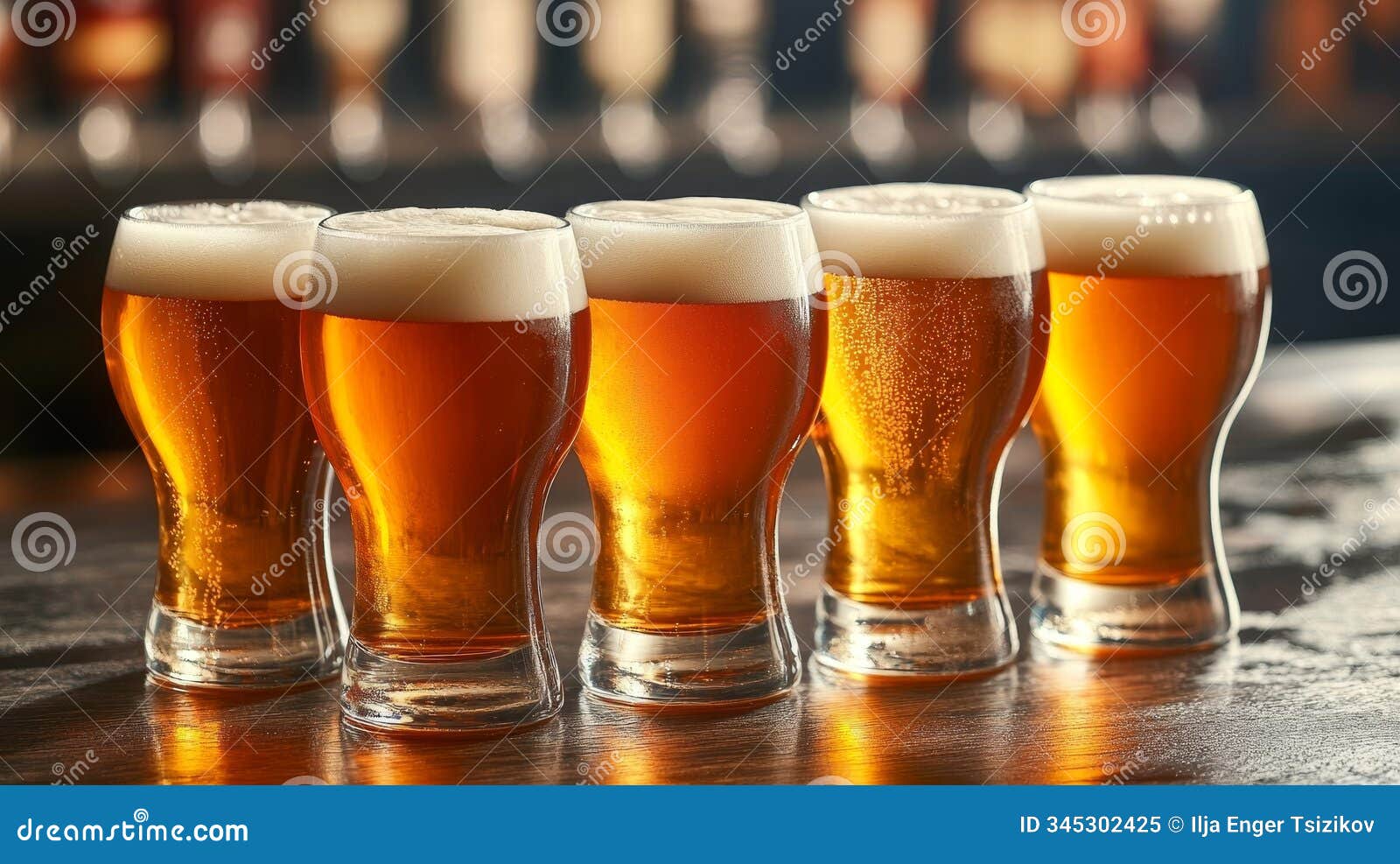 Five Fresh Cold Draft Beer Glasses in a Row on Bar Counter with Blurred ...