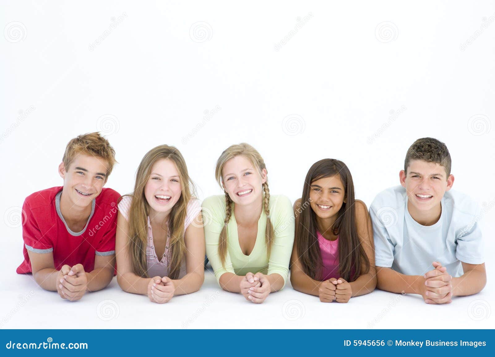 Five Friends Lying Down in a Row Smiling Stock Photo - Image of shot ...