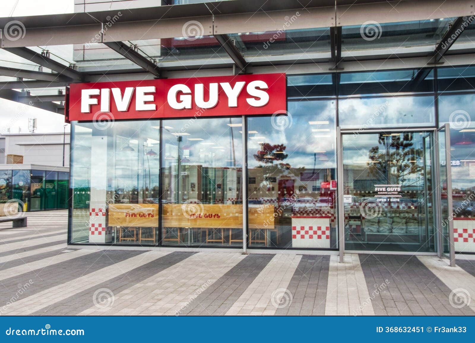 A Five Guys Burger Restaurant Logo On The Front Entrance Of The ...