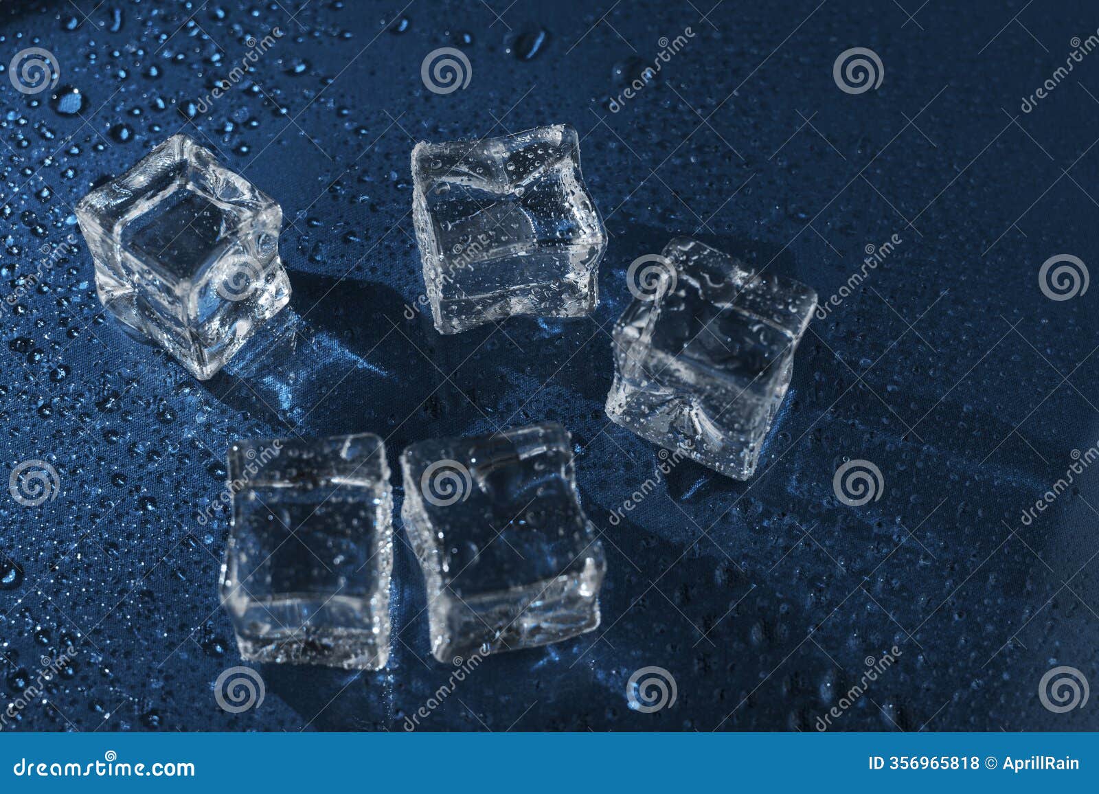Five Ice Cubes on a Reflective Blue Surface with Water Droplet Stock ...
