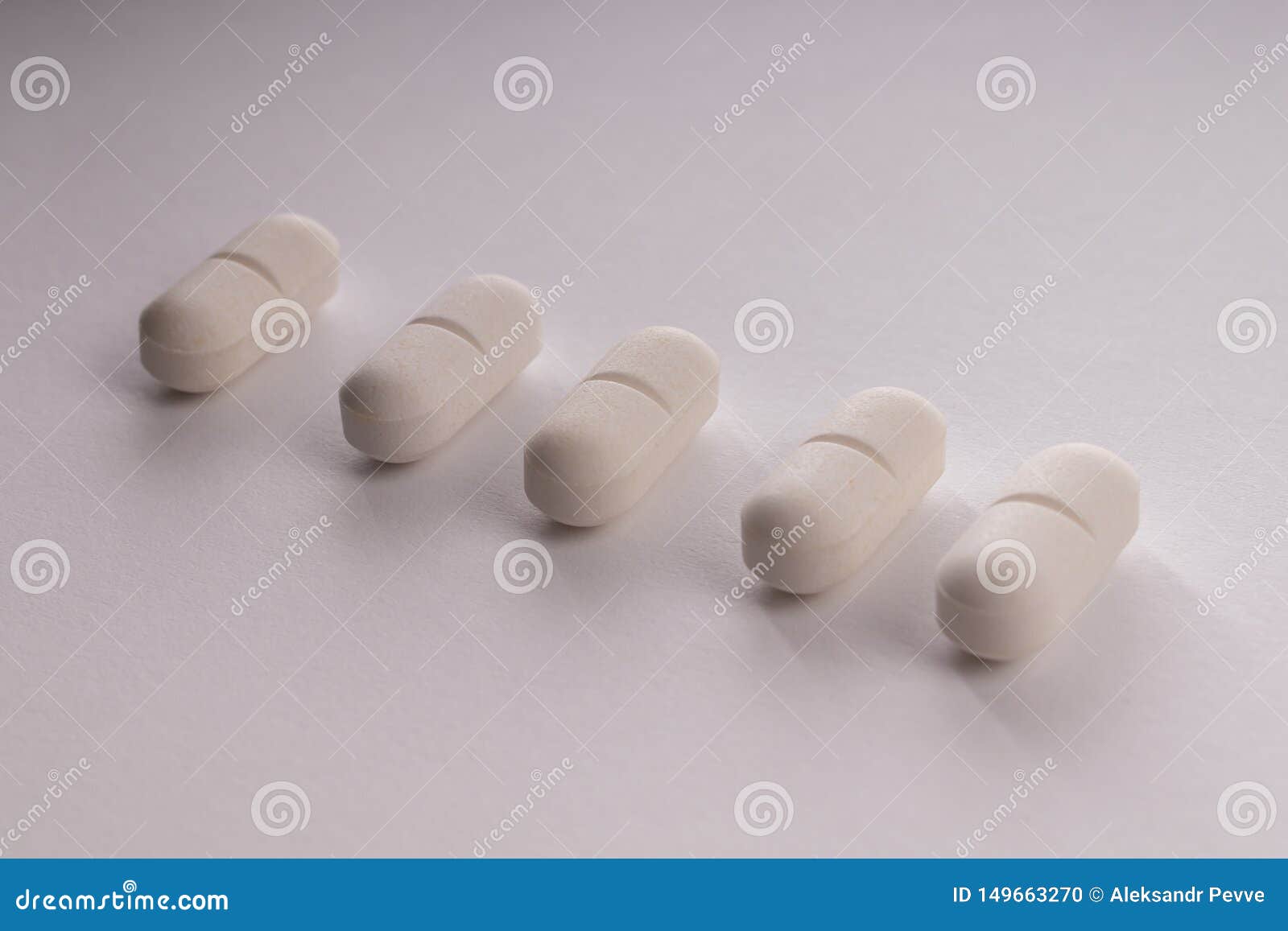 Five Light Pills in a Row on a White Background Stock Photo - Image of ...