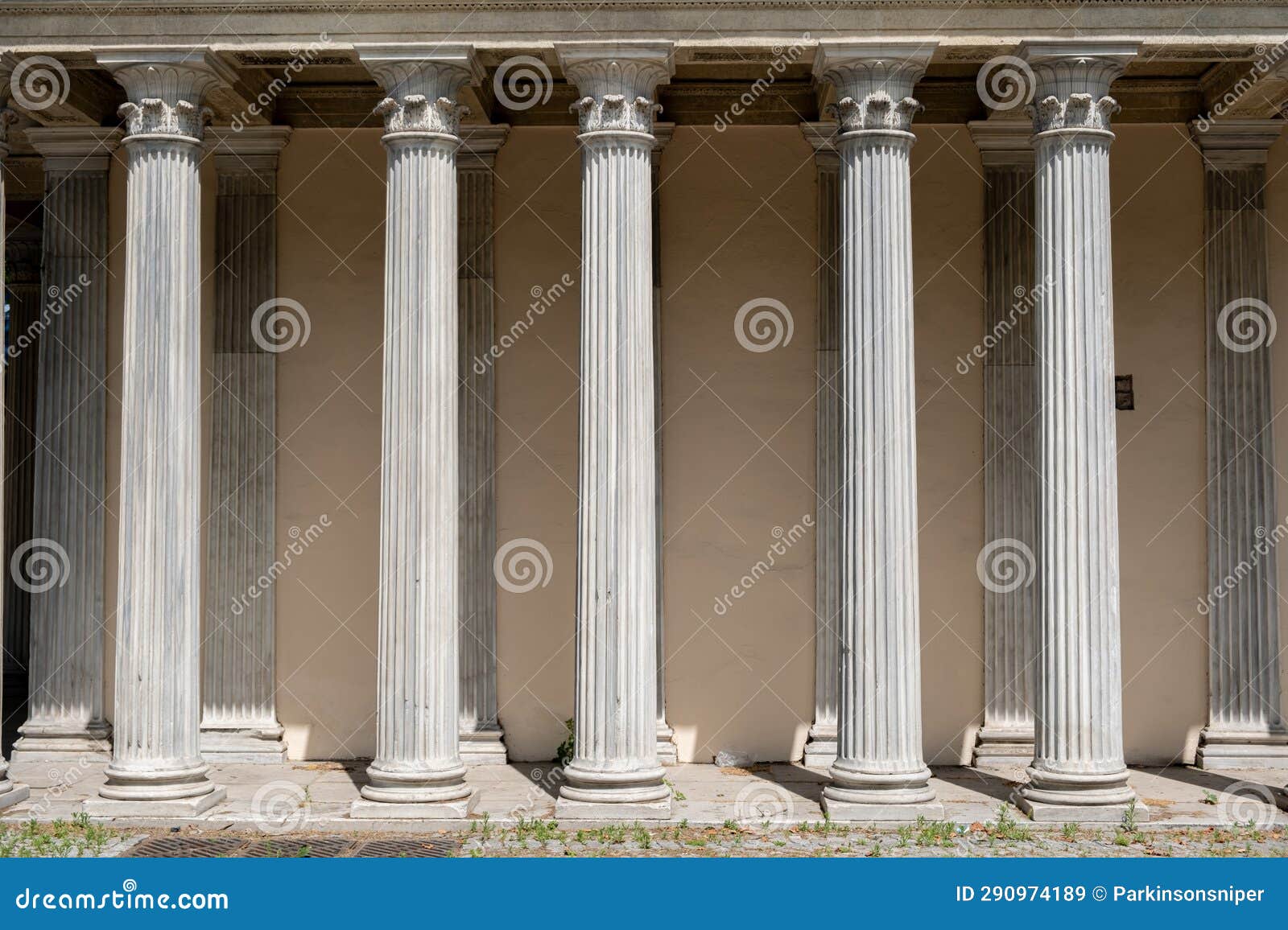 Five Marble Columns Against a Yellow Concrete Wall Stock Image - Image ...