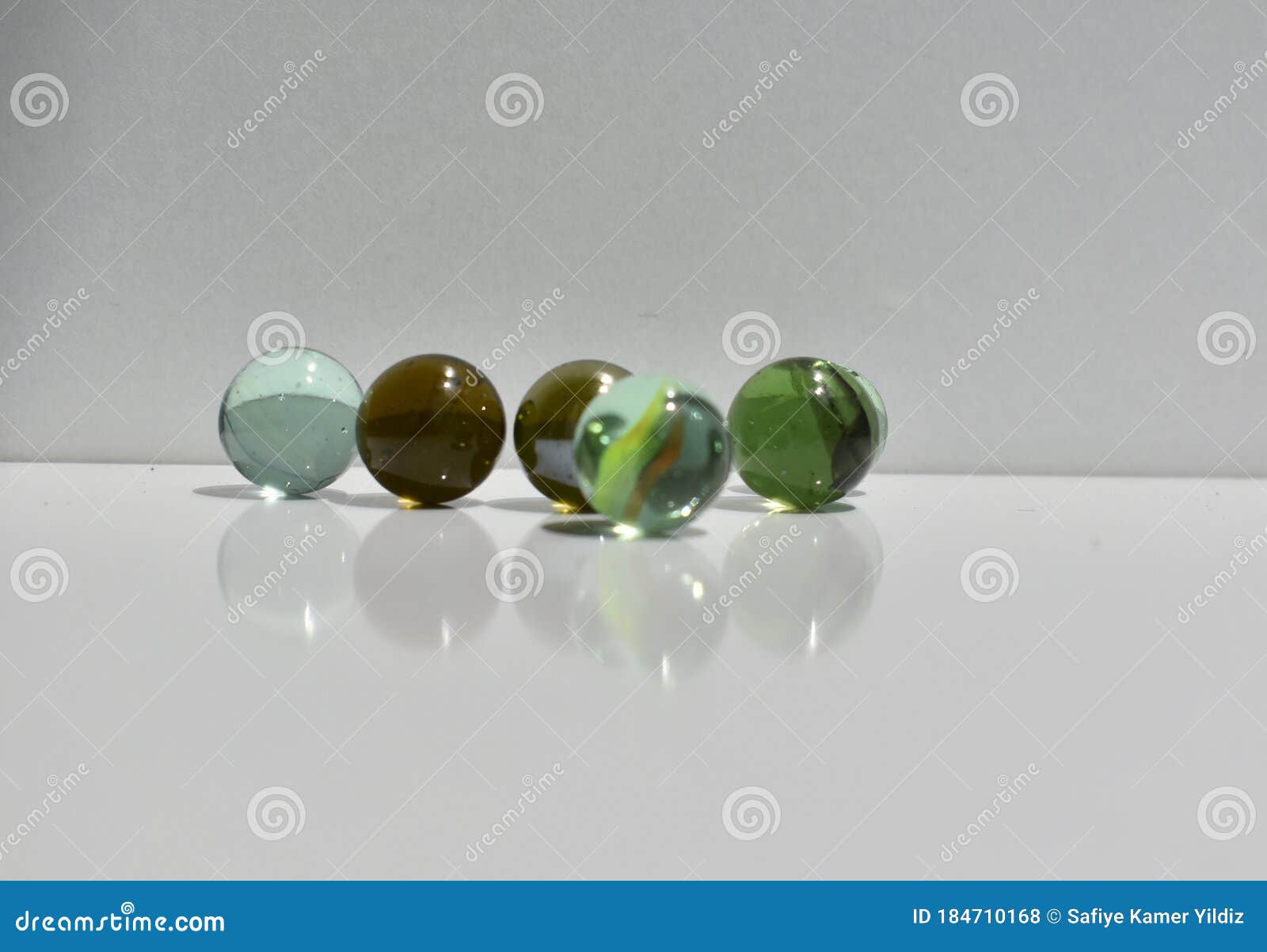 Five Marbles are Standing in a White Place. Stock Photo - Image of bead ...