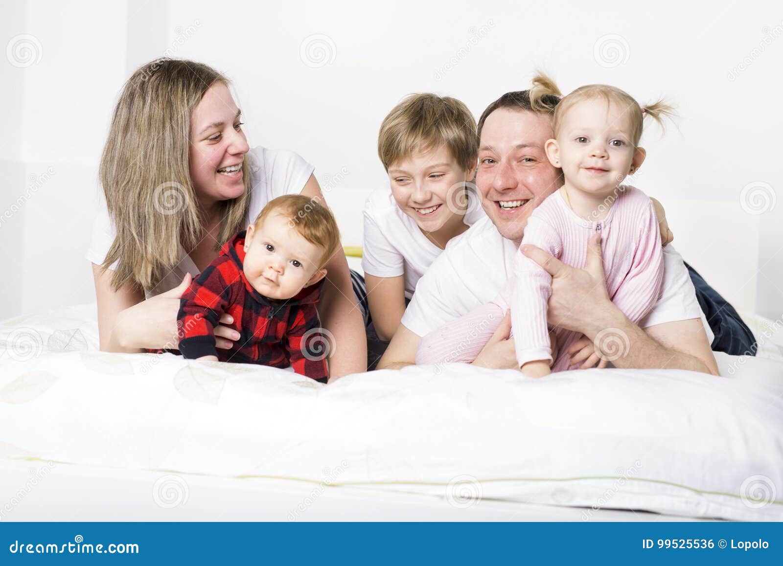 Five Member Young Family Having Fun in Bed Stock Photo - Image of ...