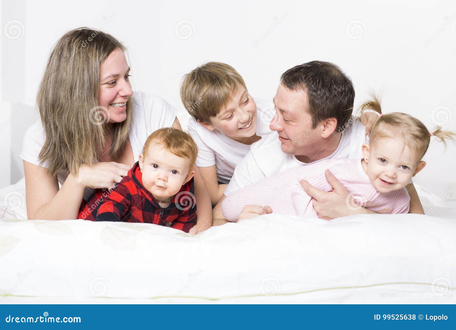 Five Member Young Family Having Fun in Bed Stock Photo - Image of ...