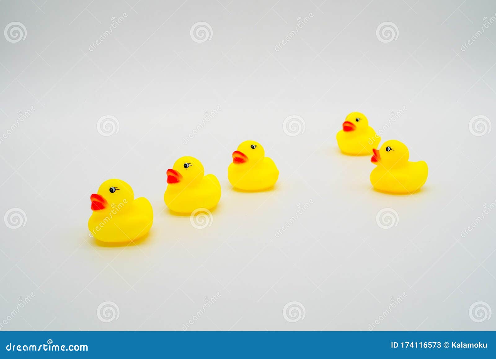 Five Mini Yellow Rubber Ducks in a Row. One Duck Making Their Wa Stock ...