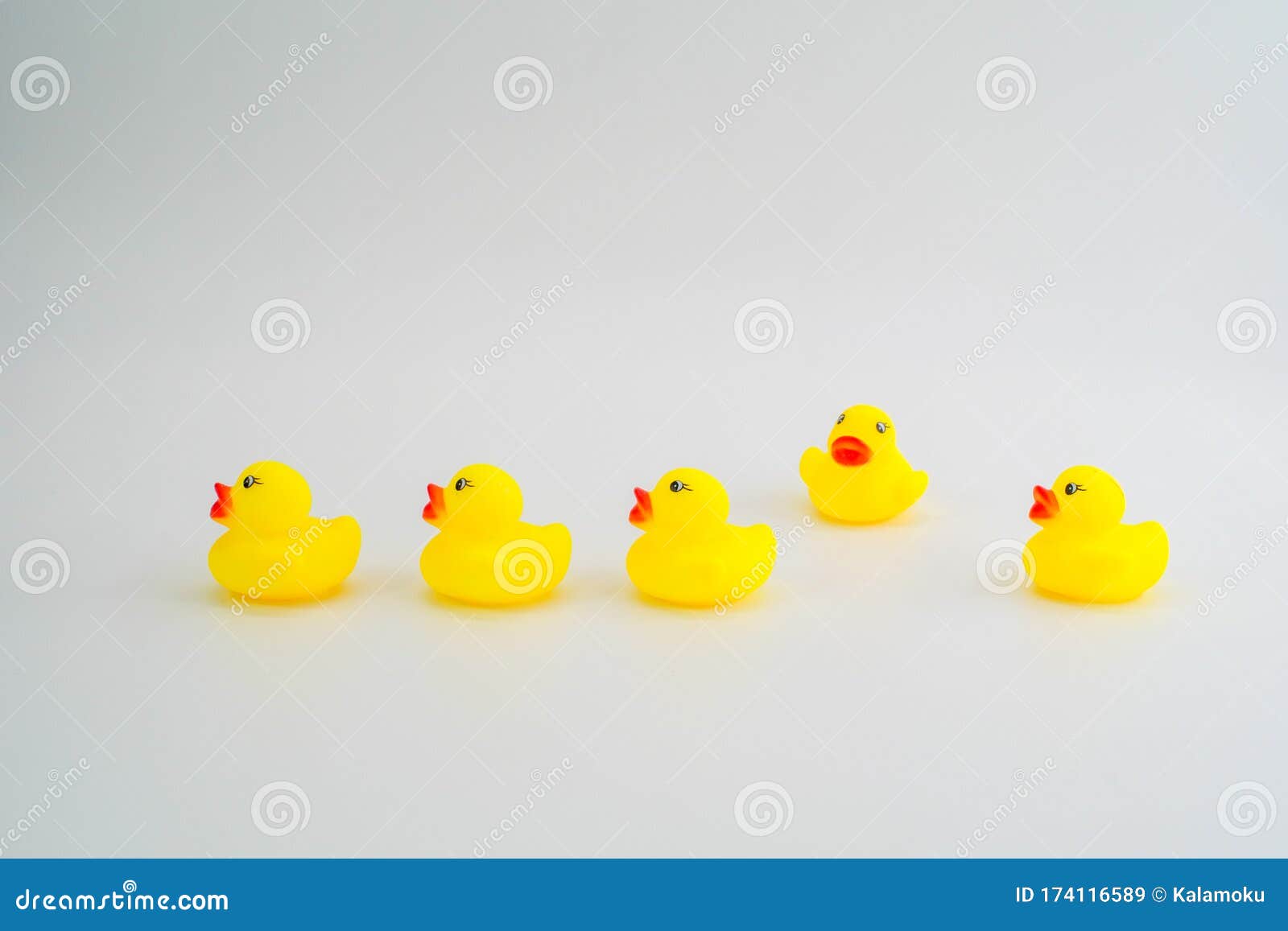 Five Mini Yellow Rubber Ducks in a Row. One Duck Making Their Wa Stock ...