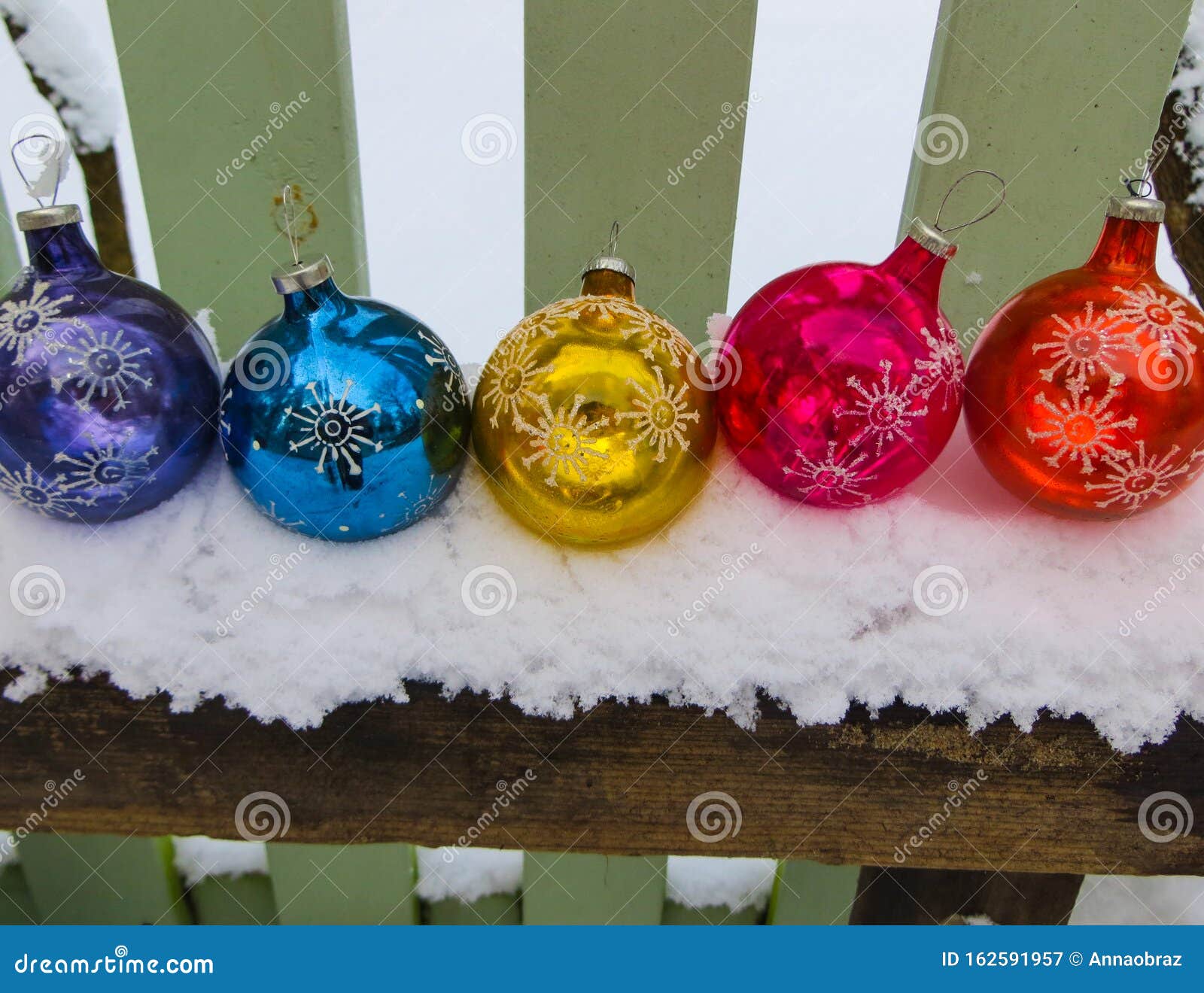 Five Multi-colored Christmas Balls in the Snow Stock Image - Image of ...