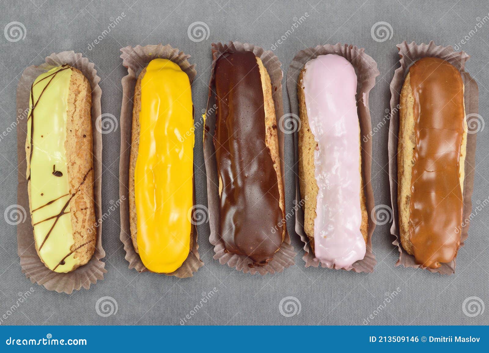 Five Multi-colored Eclairs Laid Out in Full Growth on a Gray Background ...